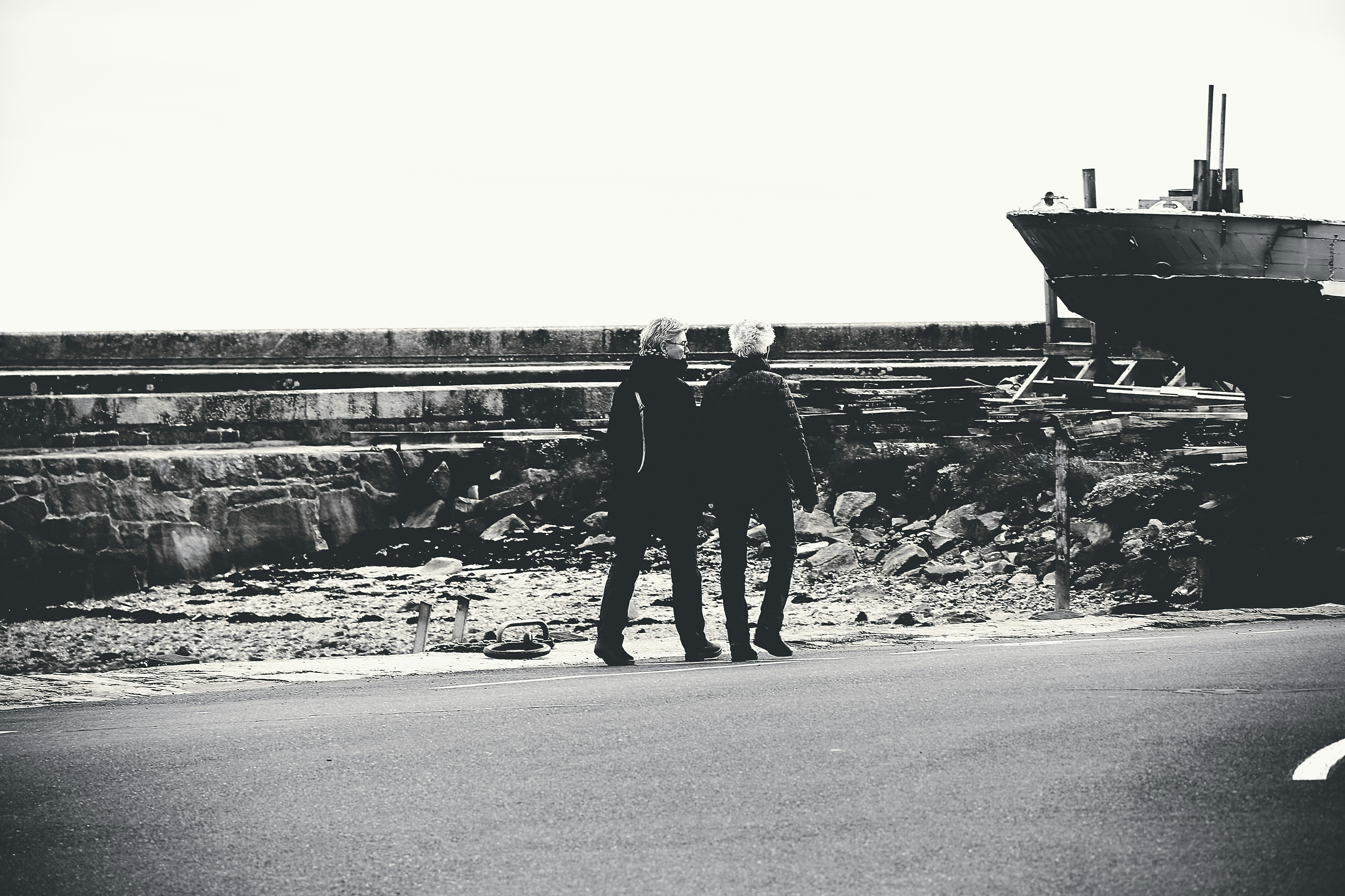Edge of the Pier: Two Figures in a Quiet Harbor Moment
