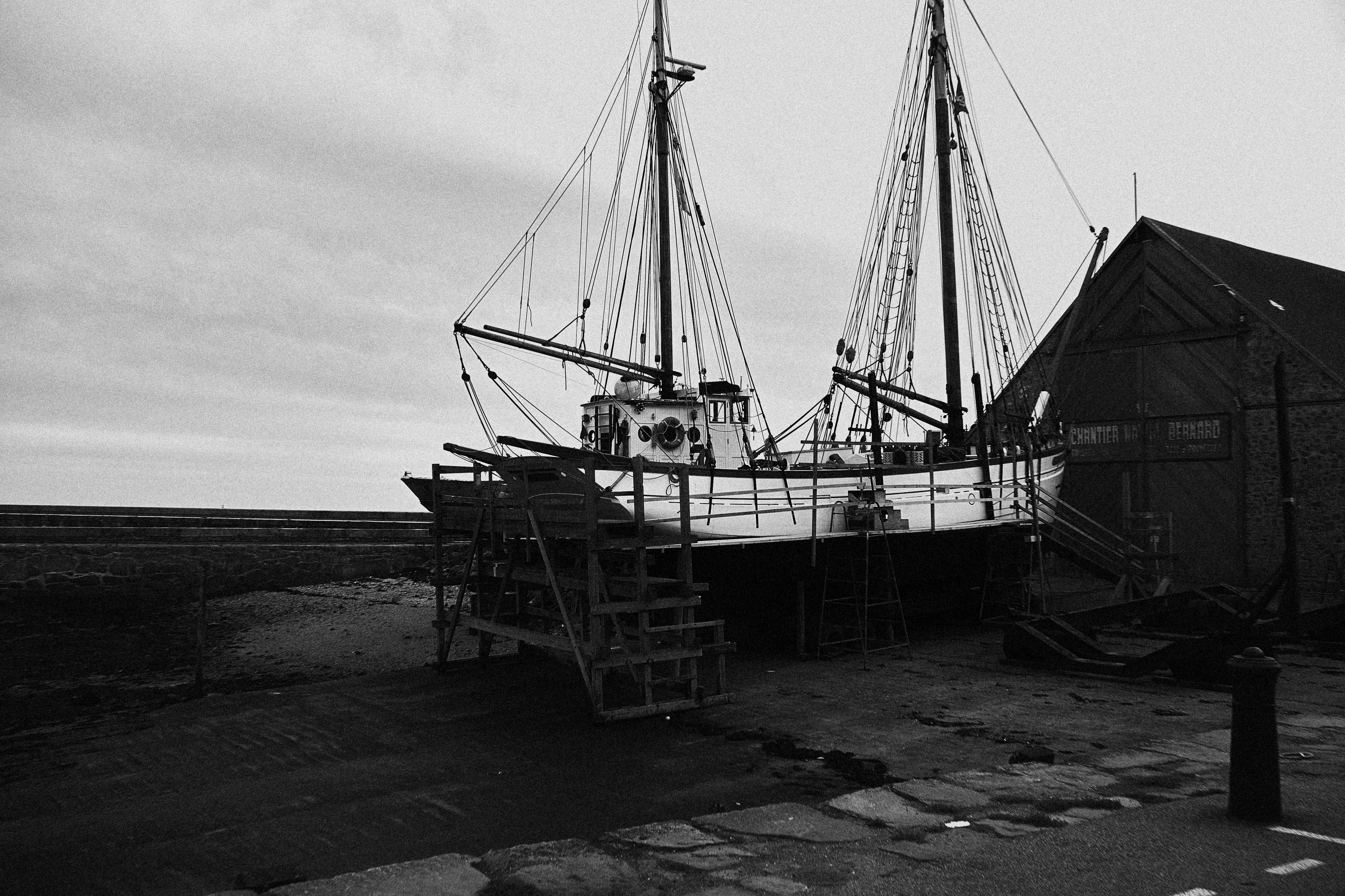 Harbor Vessel in Silence: A Black-and-White Seascape with a Dockside Ship