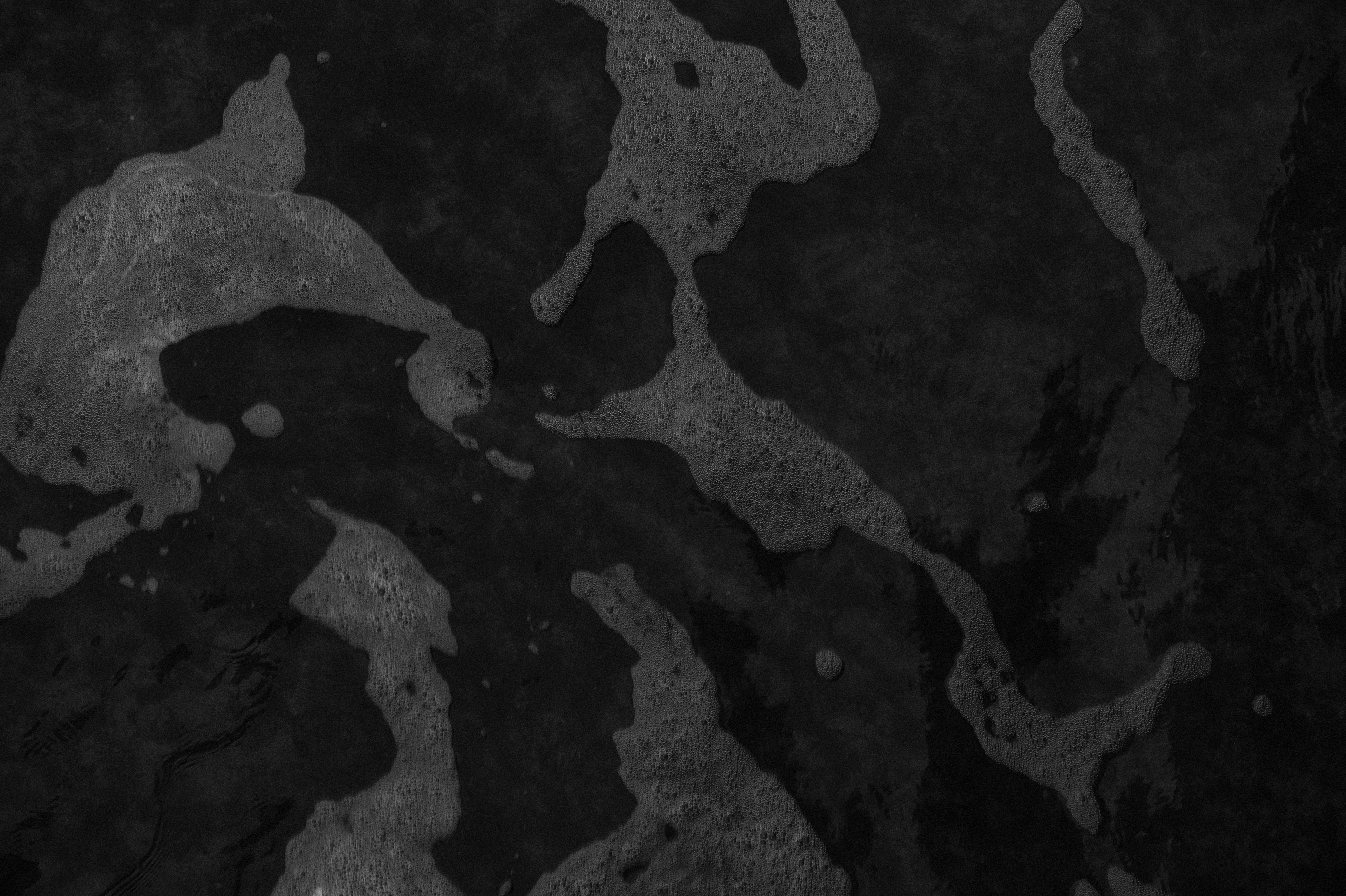 Monochrome Currents: Abstract Fluid Forms in Dark Granite