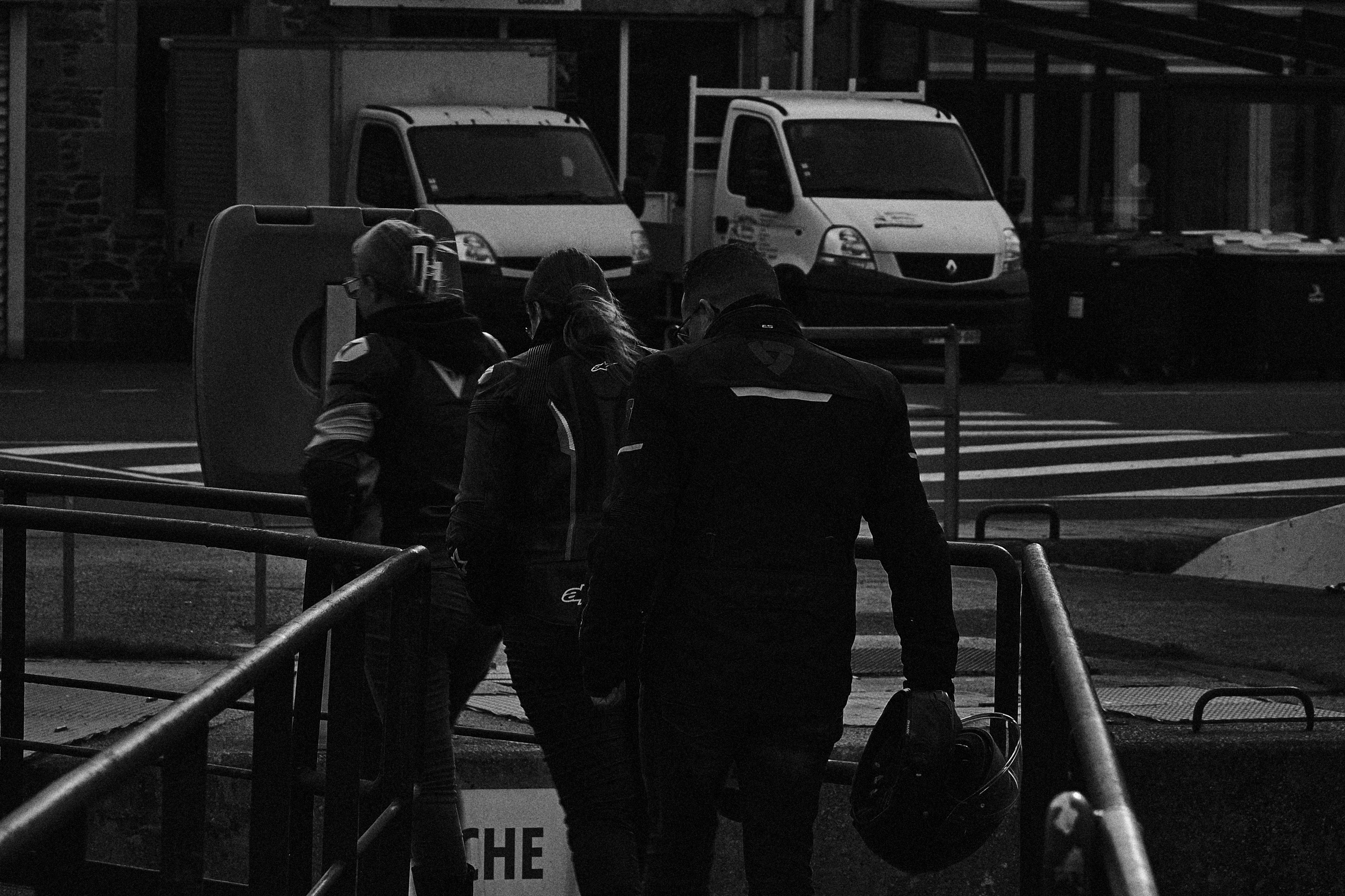 Silent Assembly: Figures Descend from the Street into the Night