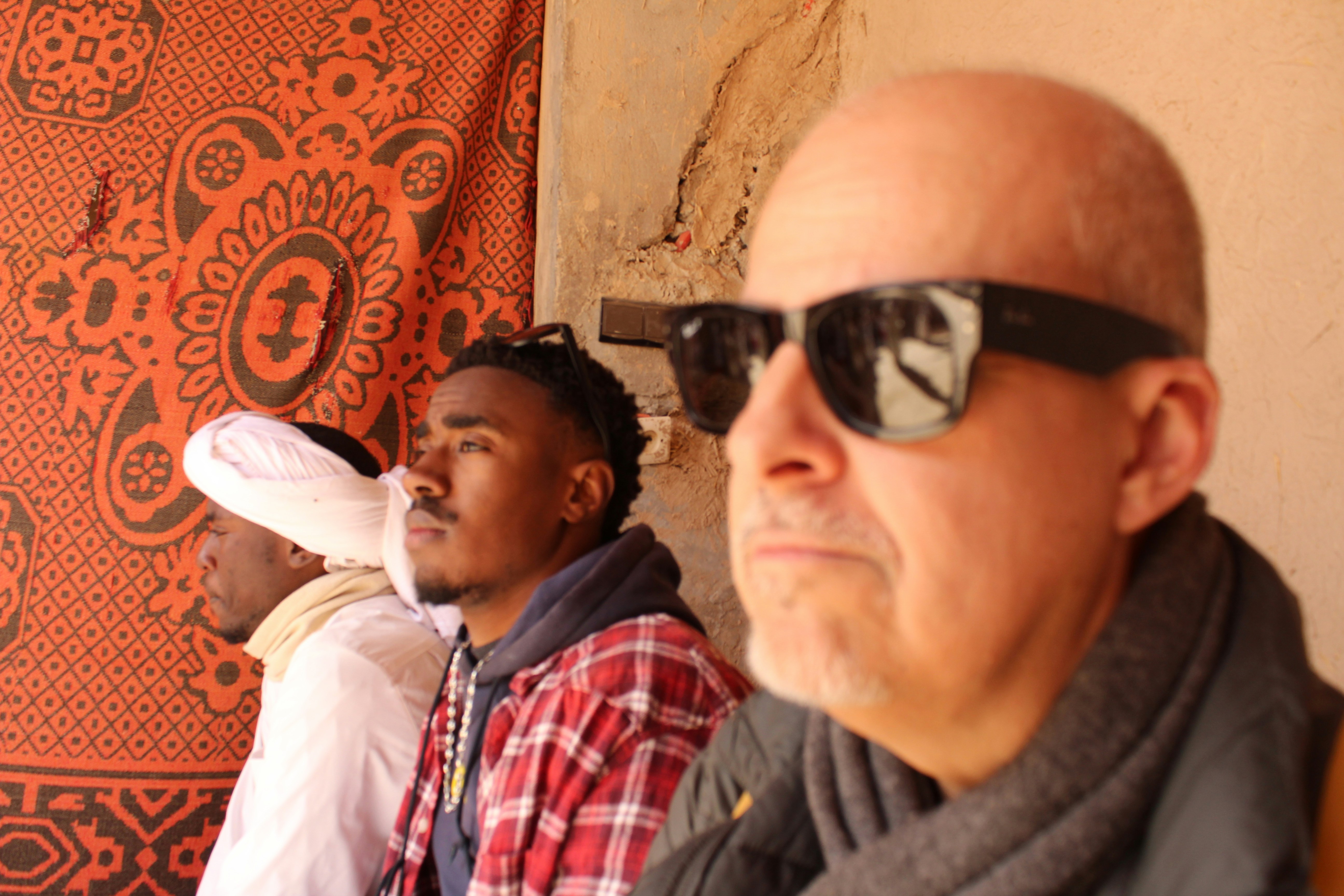 Three Men in Shade: Portrait of Vigilant Quietude