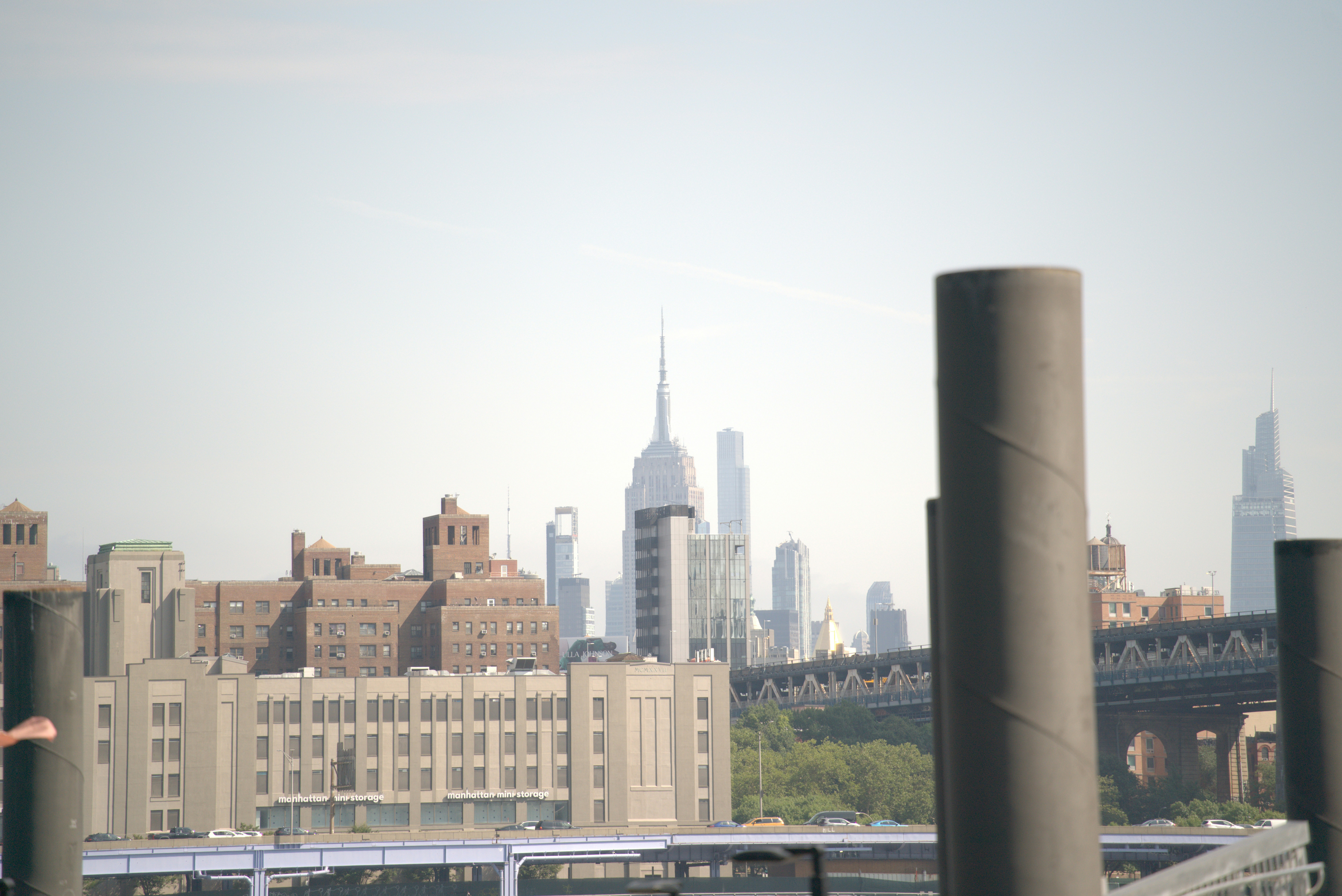 Rooftop View: Distant Skyline Emerging Over Frontline Cylinders