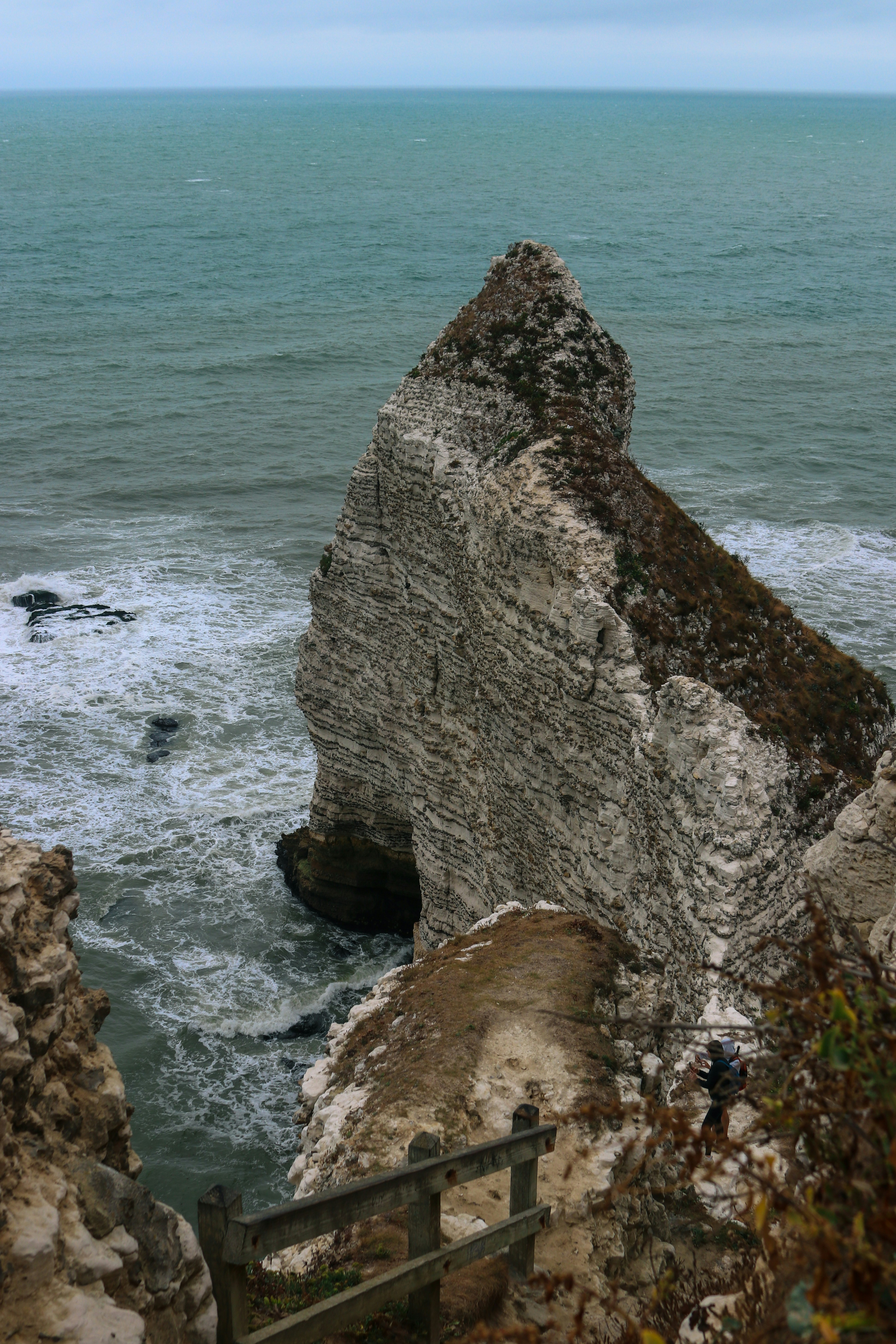 Sea-stone Spire: A Cliff’s Silhouette Against the Turquoise Vastness
