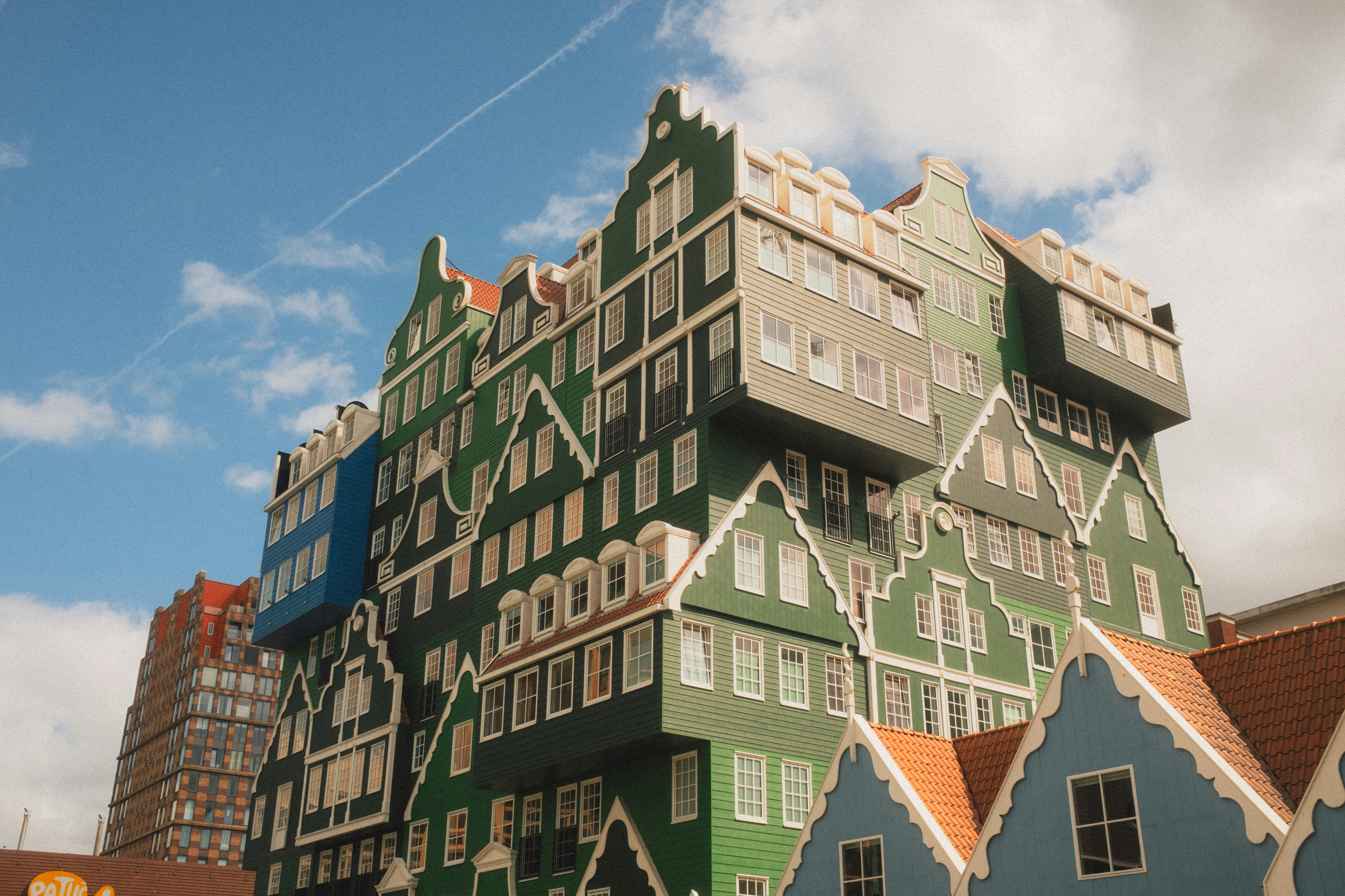 Colorful stacked houses rise in a playful skyline