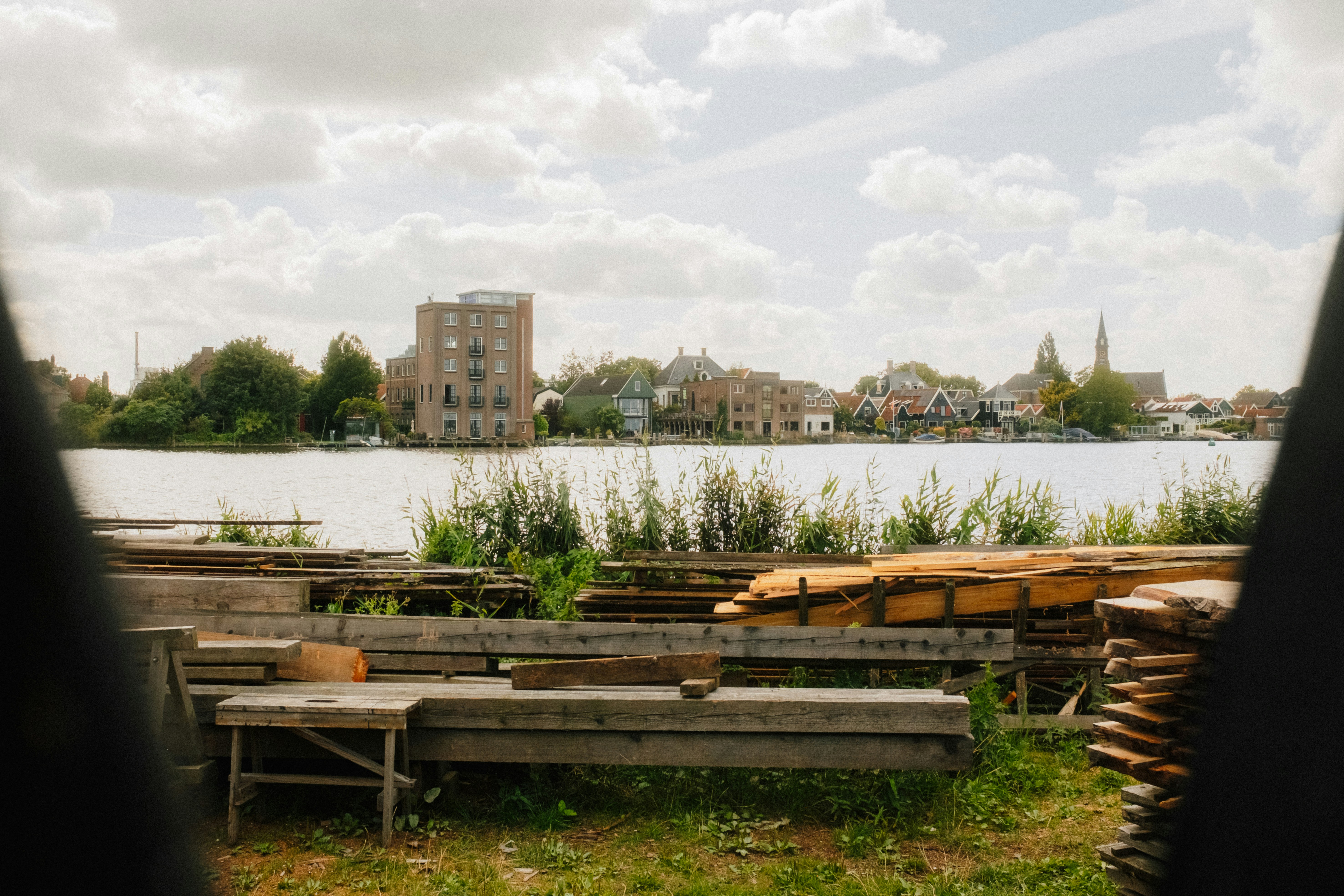Reflected Townscape Beyond a Woodpile Frame