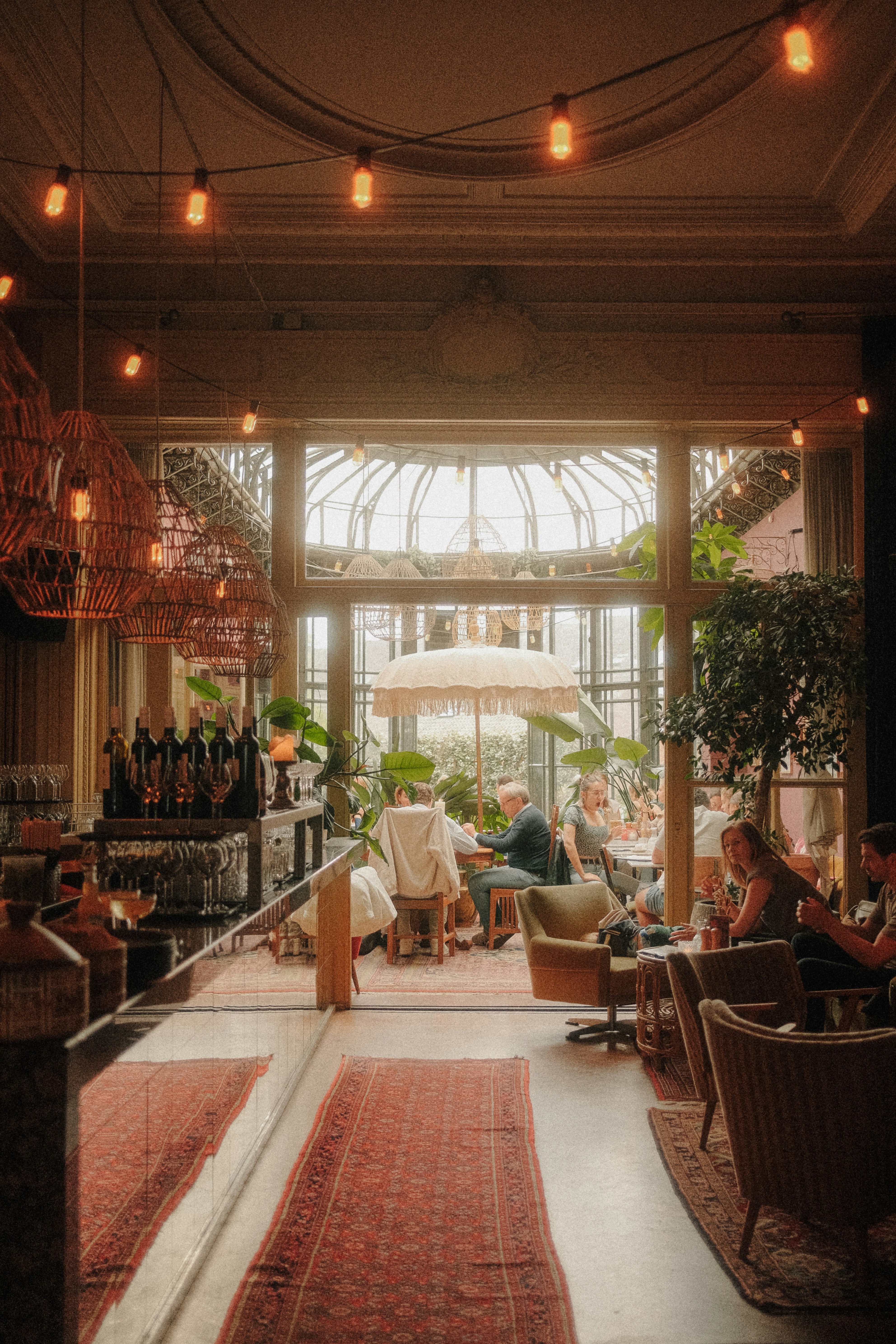 Sunlit Conservatory Café: Evening Glow Behind Glass