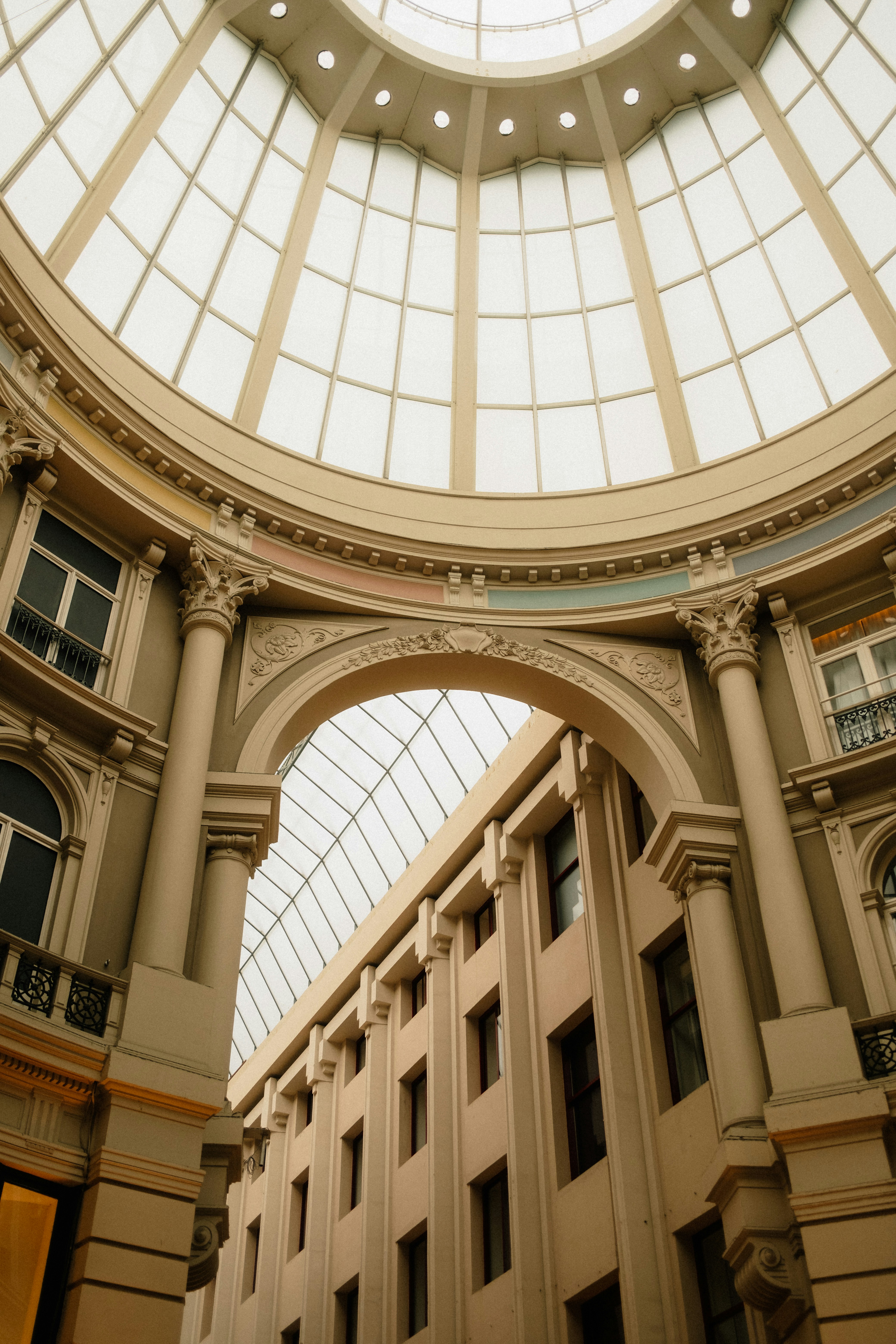 Domed Atrium Arc: Glass Ceiling Meeting Stone Arches