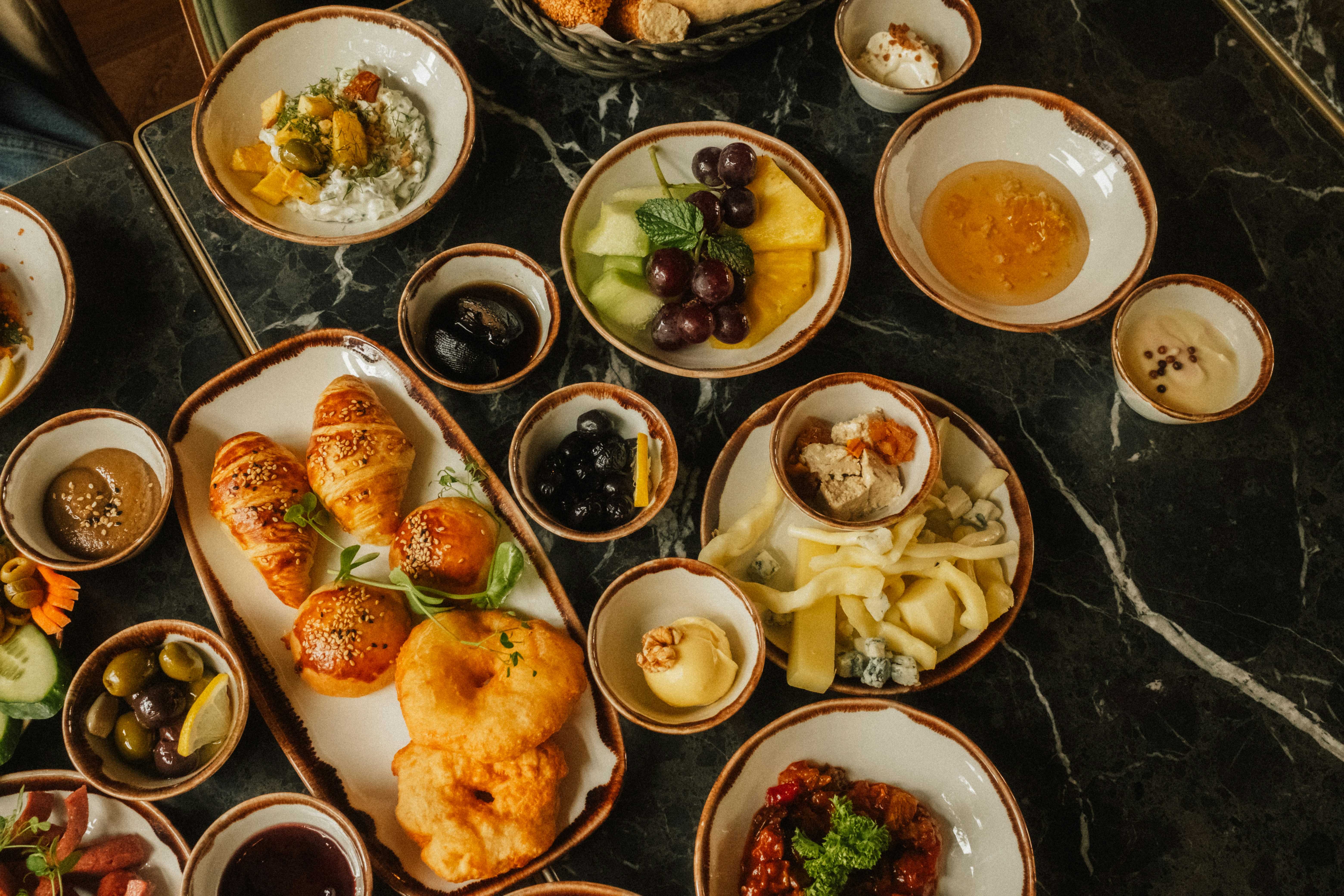 Overhead feast: a vibrant banquet of pastries, fruits, and small plates
