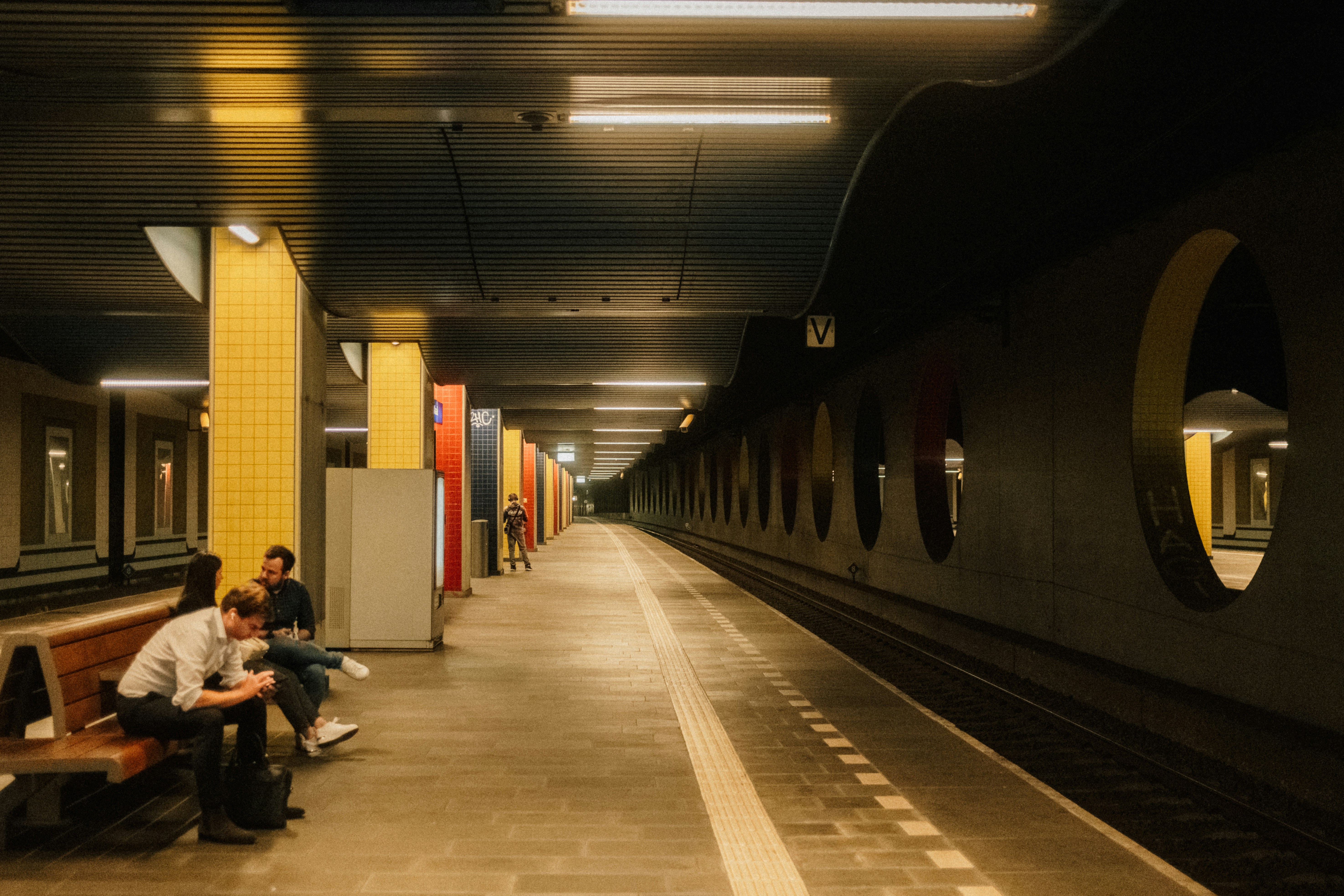 Underground Quiet: A Line of Orange Seats and Distant Rails