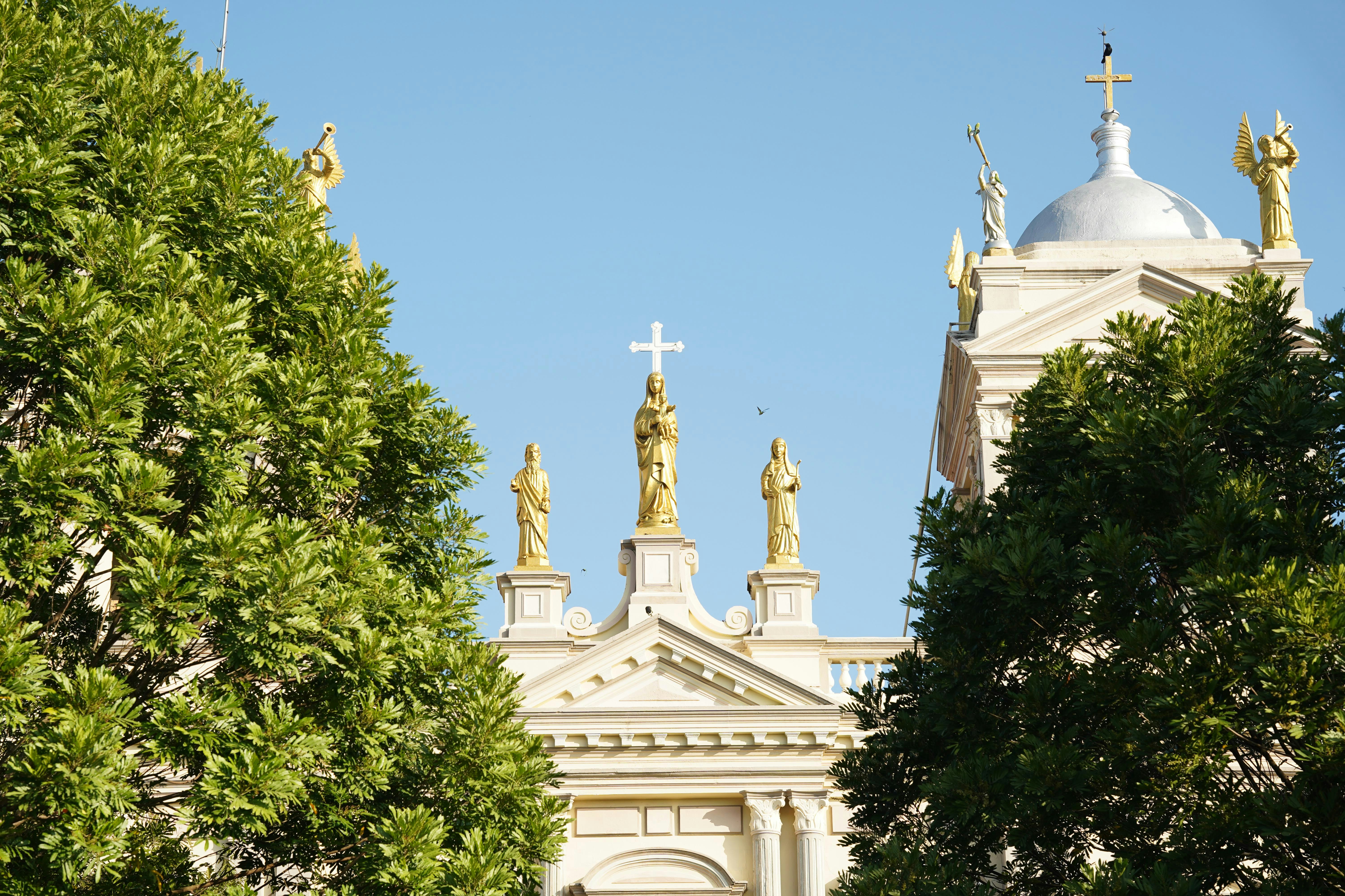 Statues and Pediment Crowned by Blue Sky