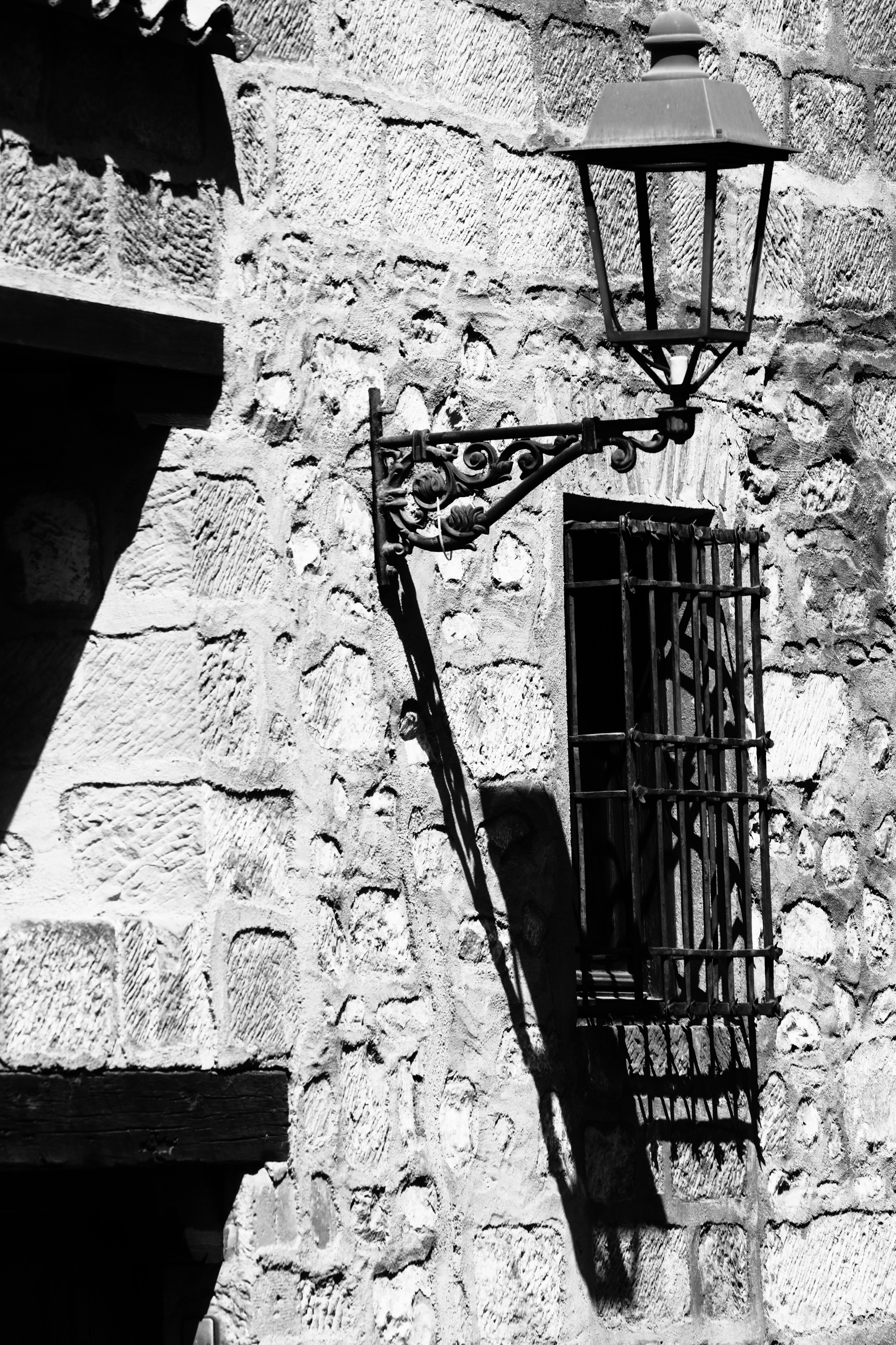 Lightning at the Lattice: A Stone Facade and Lantern Shadow