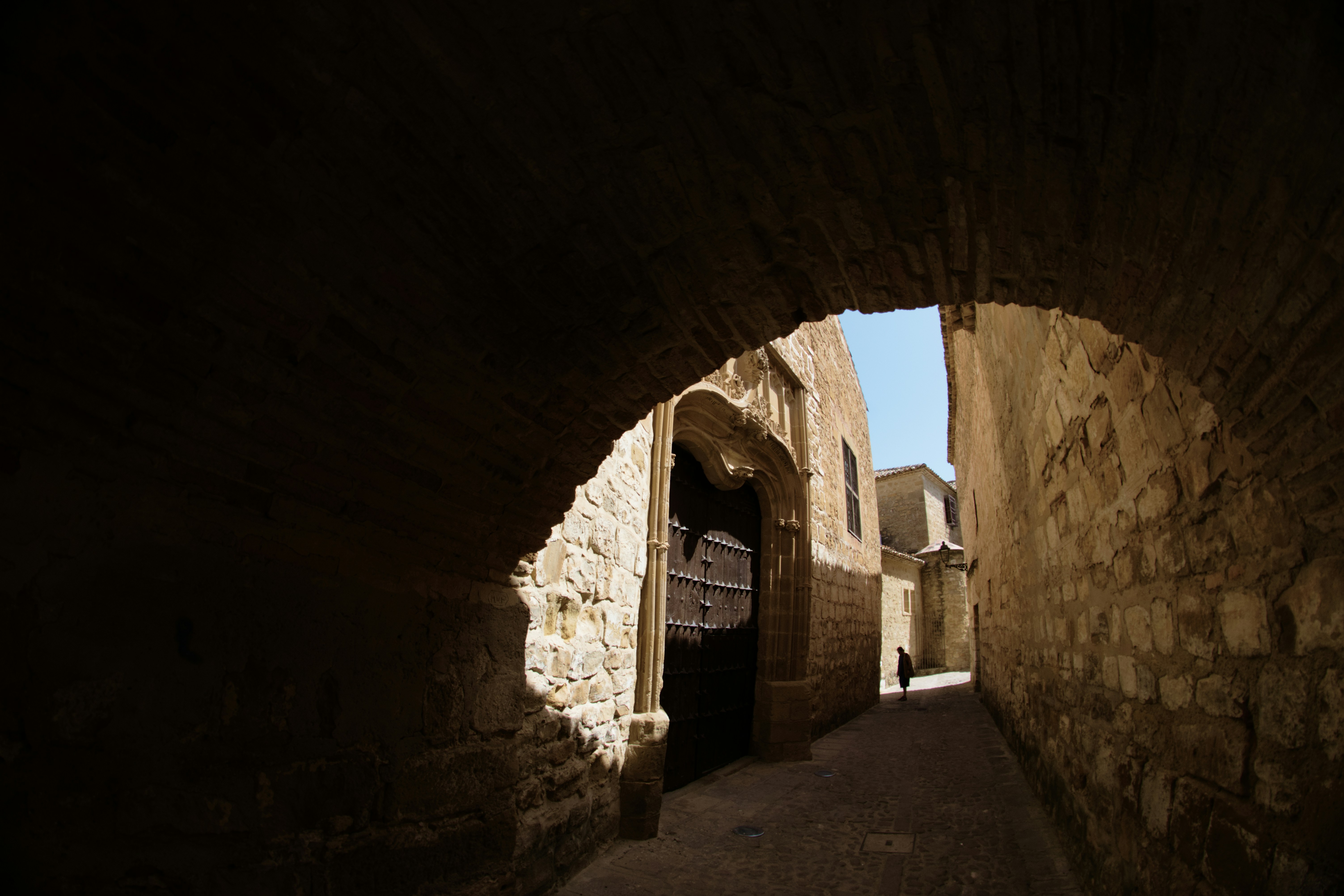 Through the Stone Archway: Morning Light in the Walled Alley