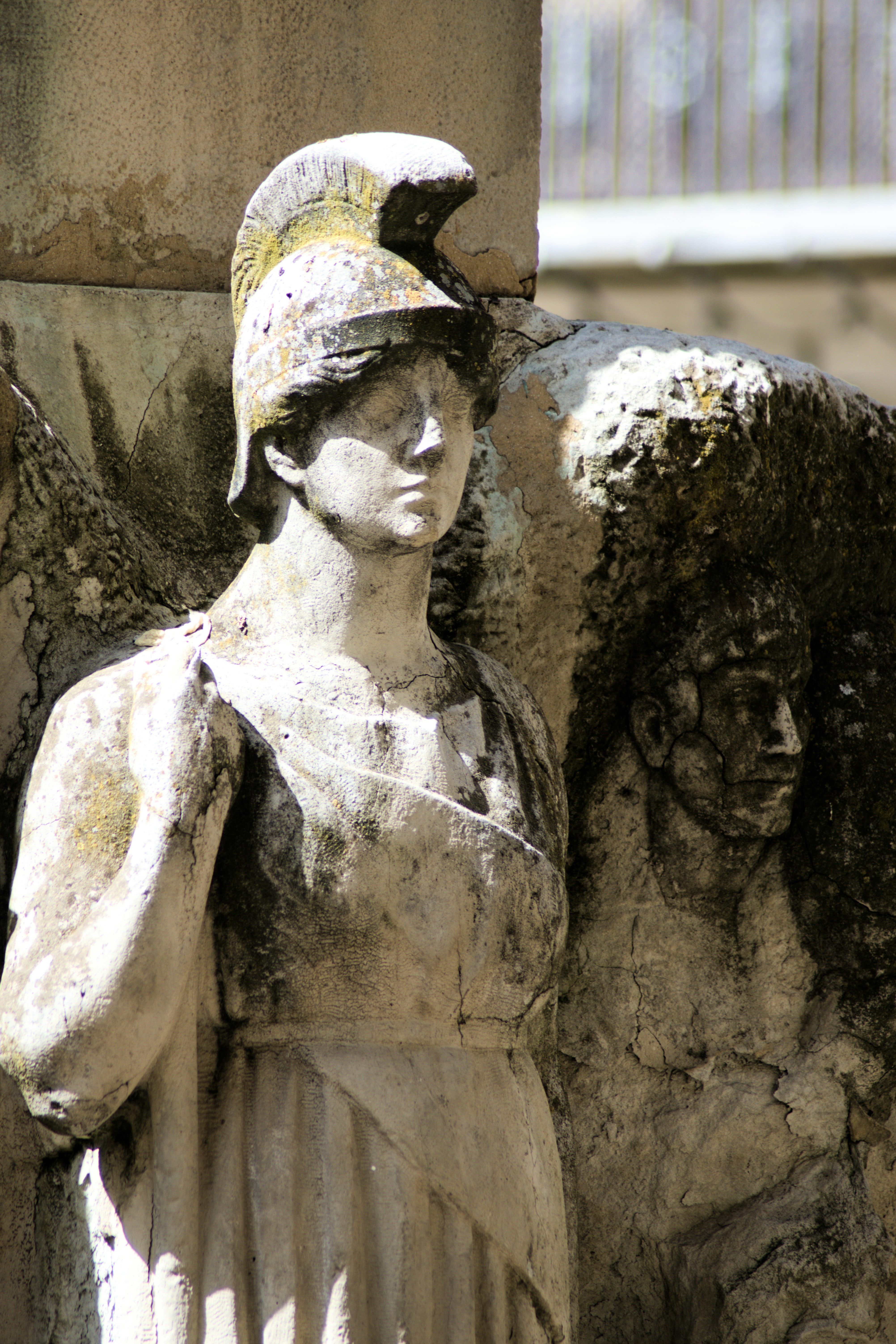 Weathered Sentinel: A Pair of Stone Figures in Quiet Deterioration