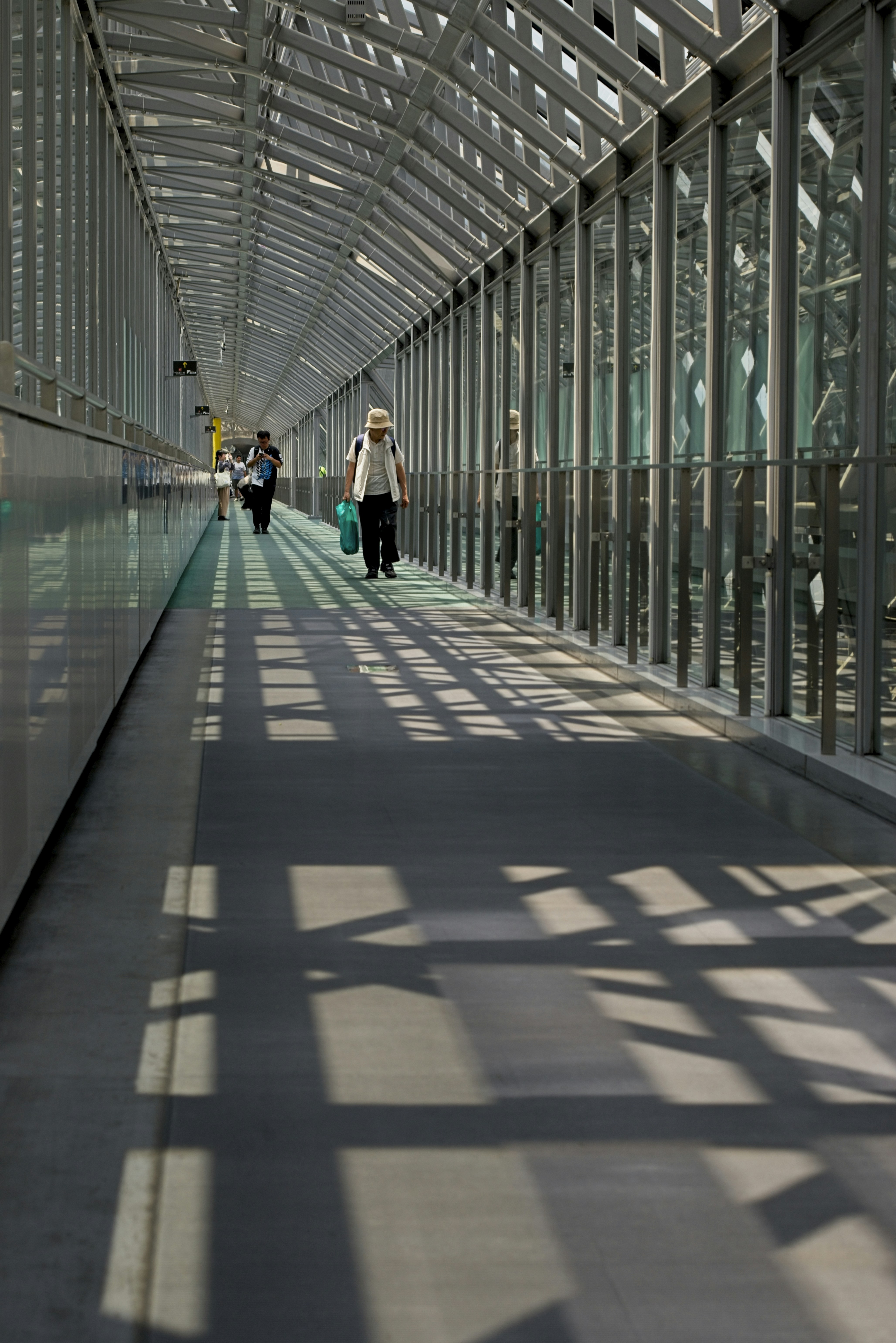 Glass Cathedral Corridor: Light and Shadow on the Transit Walk