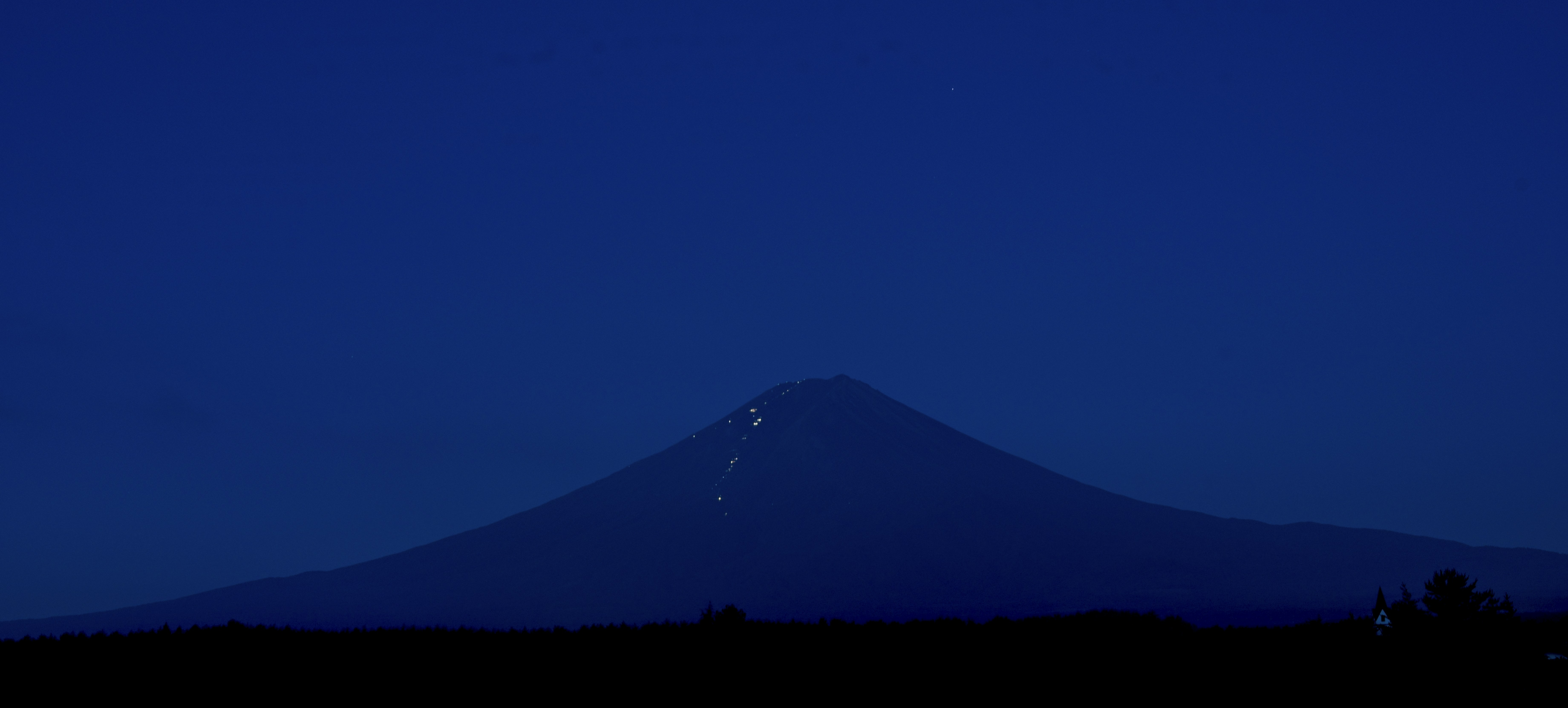 Midnight Sentinel: A Lone Volcano Silhouetted Against a Velvet Sky