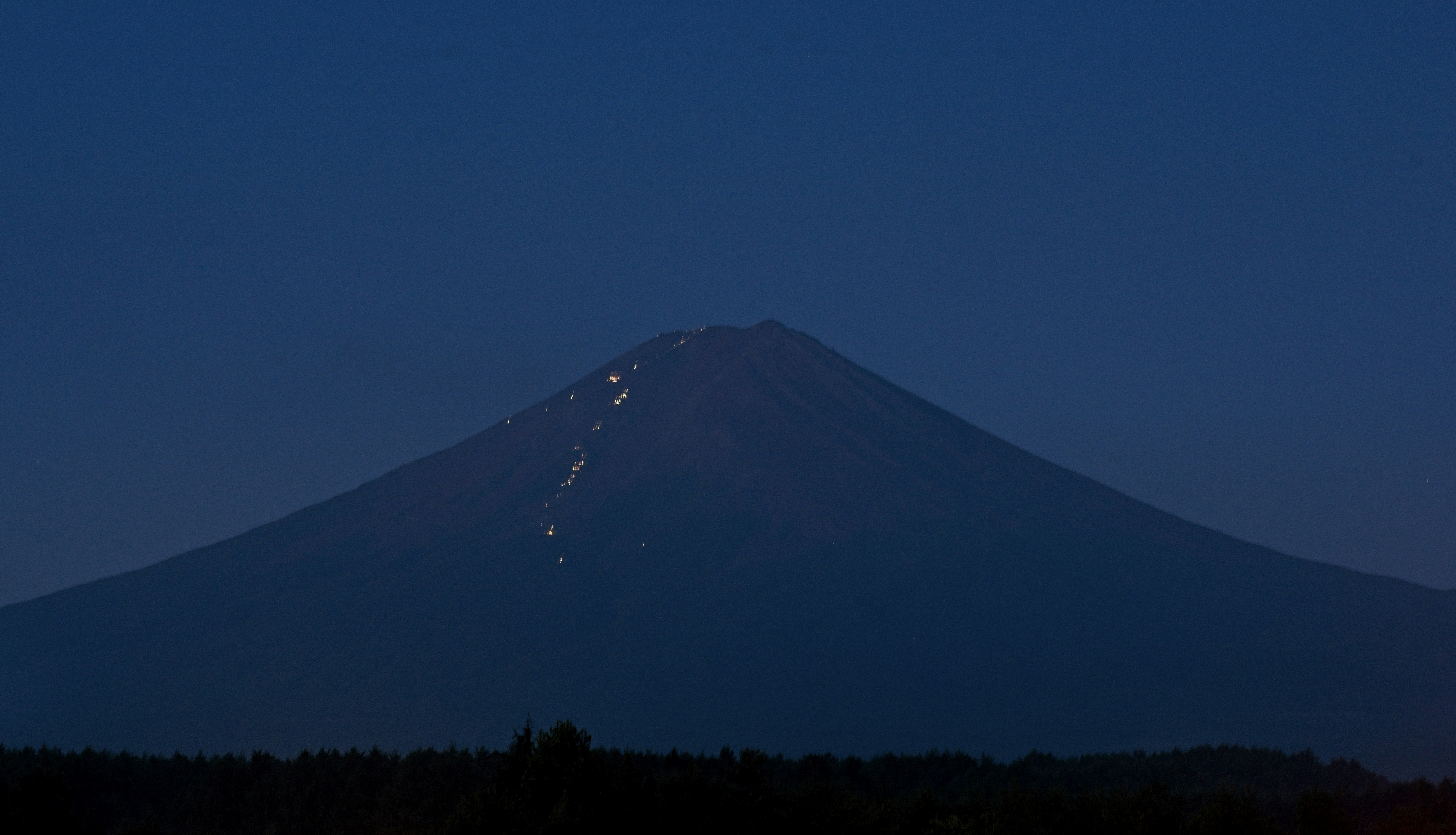 Moonlit Summit: A Silent Nightfall Over the Ridge