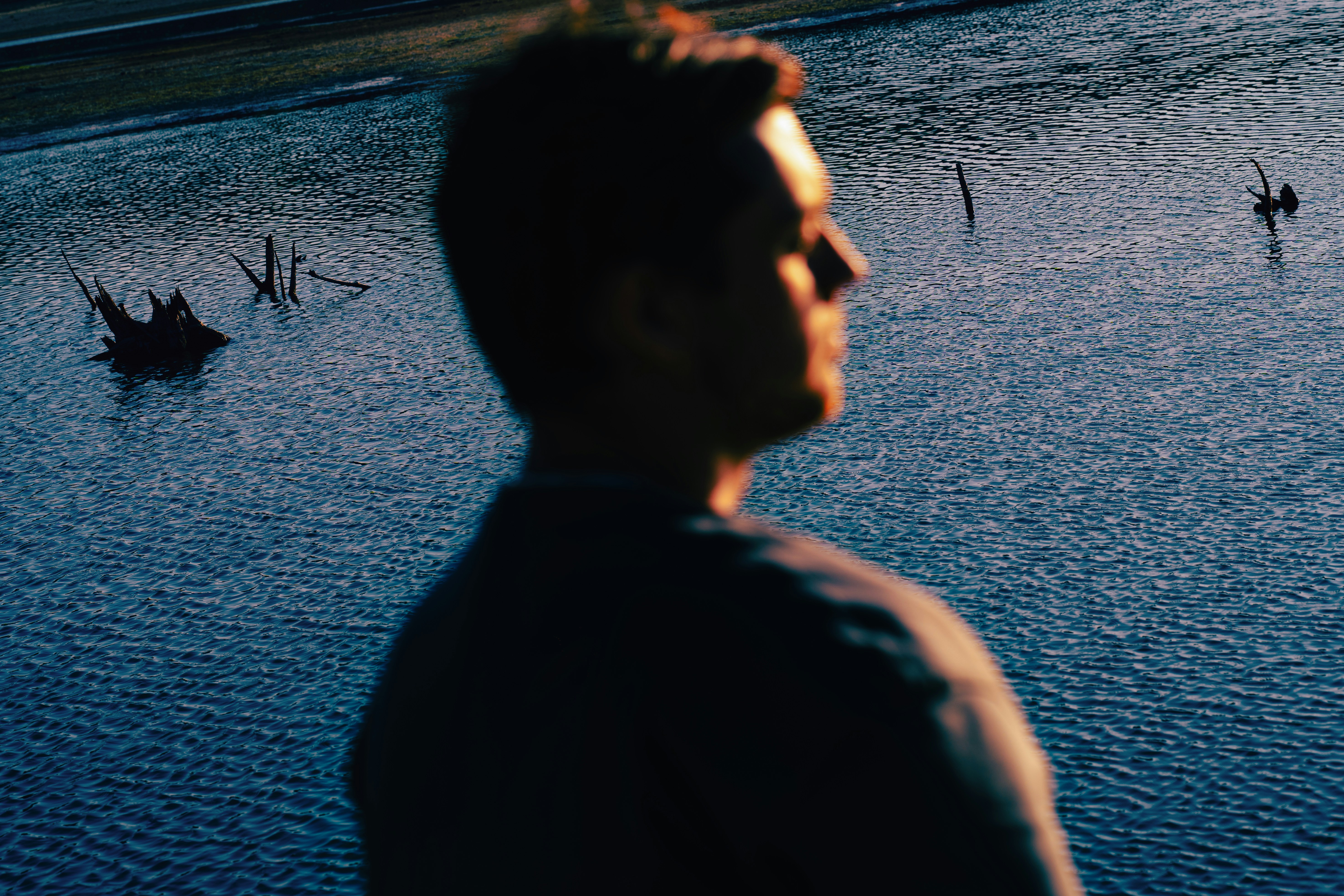 Blurred silhouette against a tranquil water backdrop