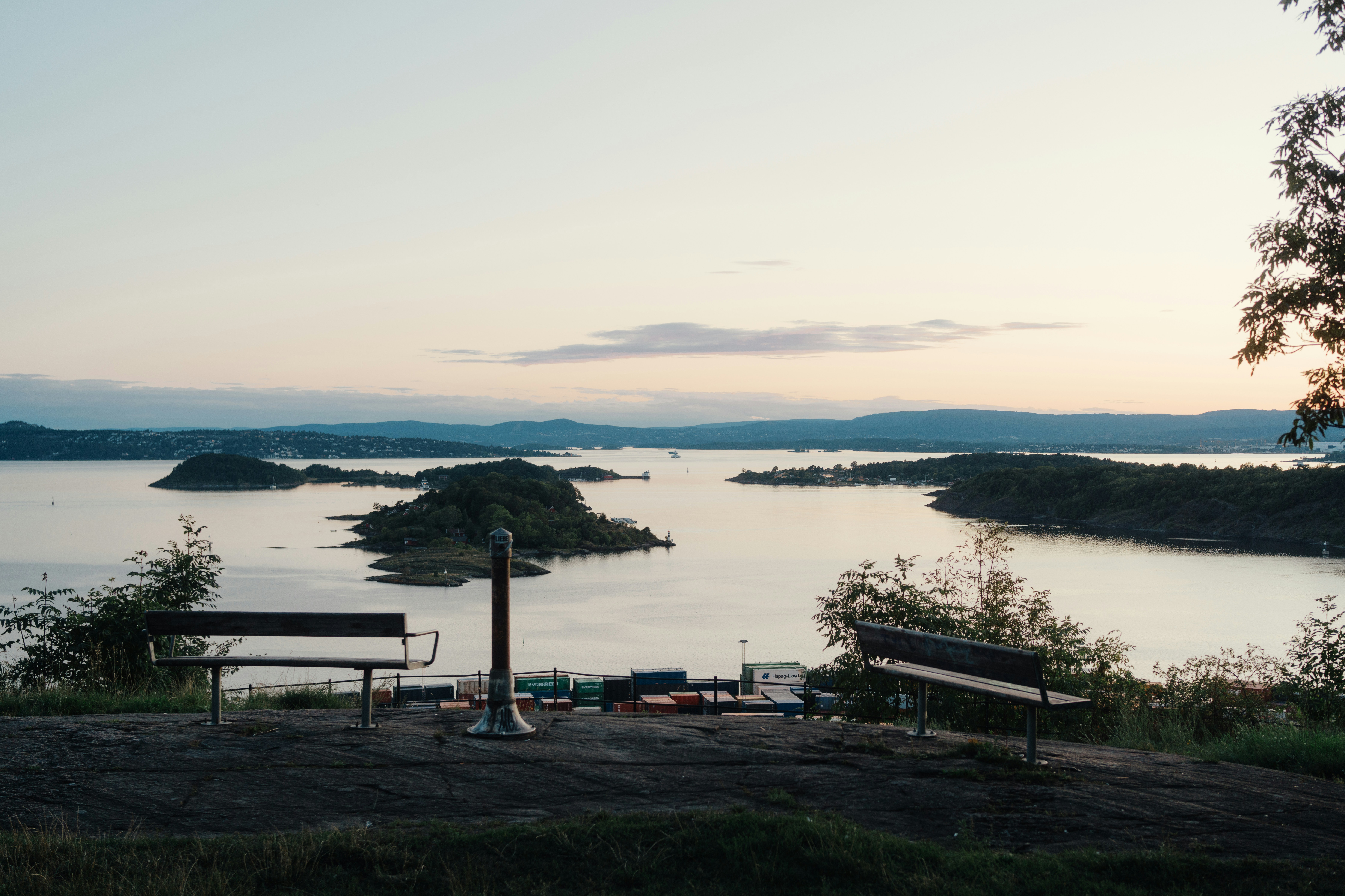 Dawn Over a Quiet Harbor: Benches, Promenade, and Islands