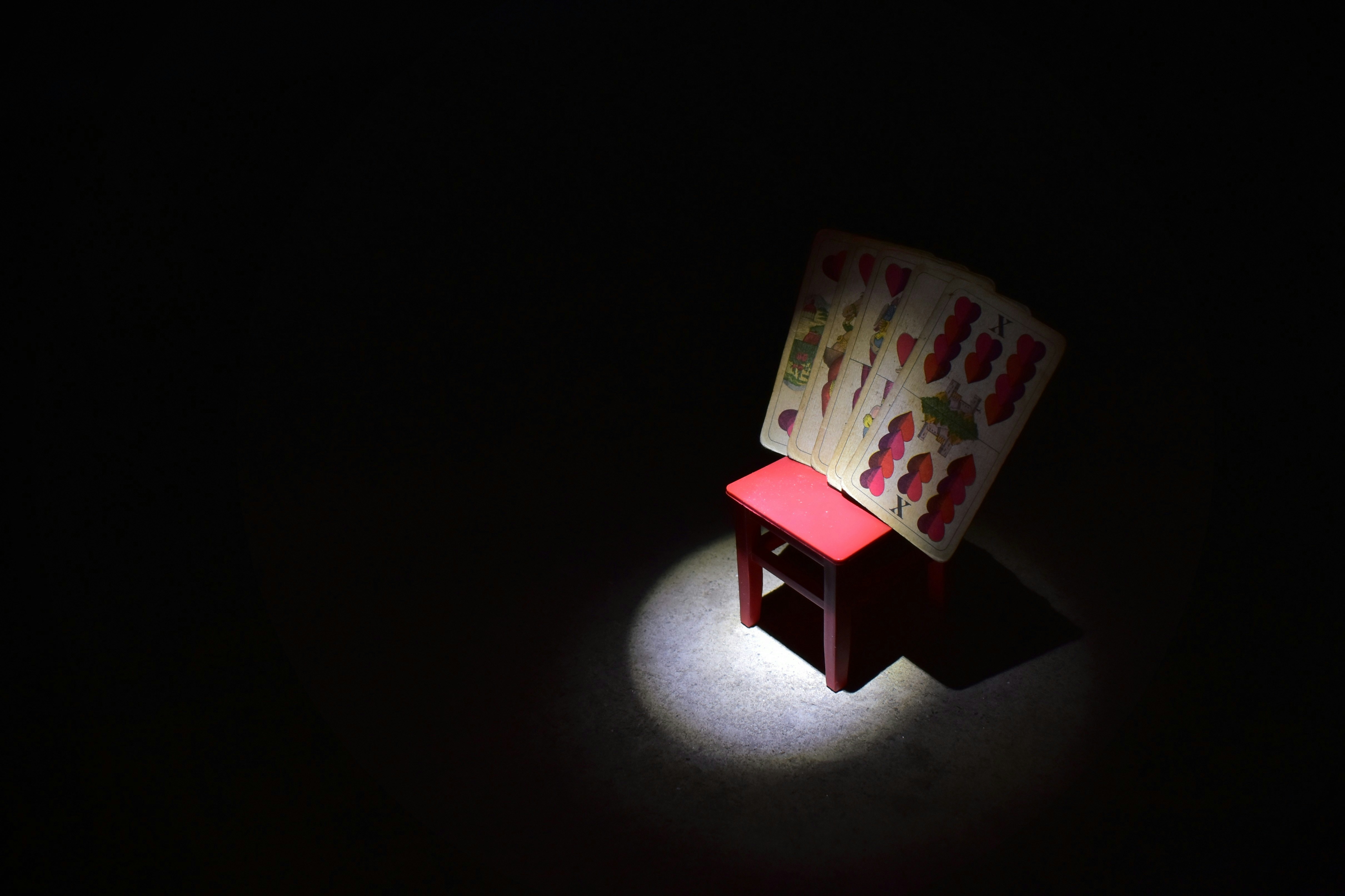 Spotlight Chair: A Red Seat in a Sea of Darkness
