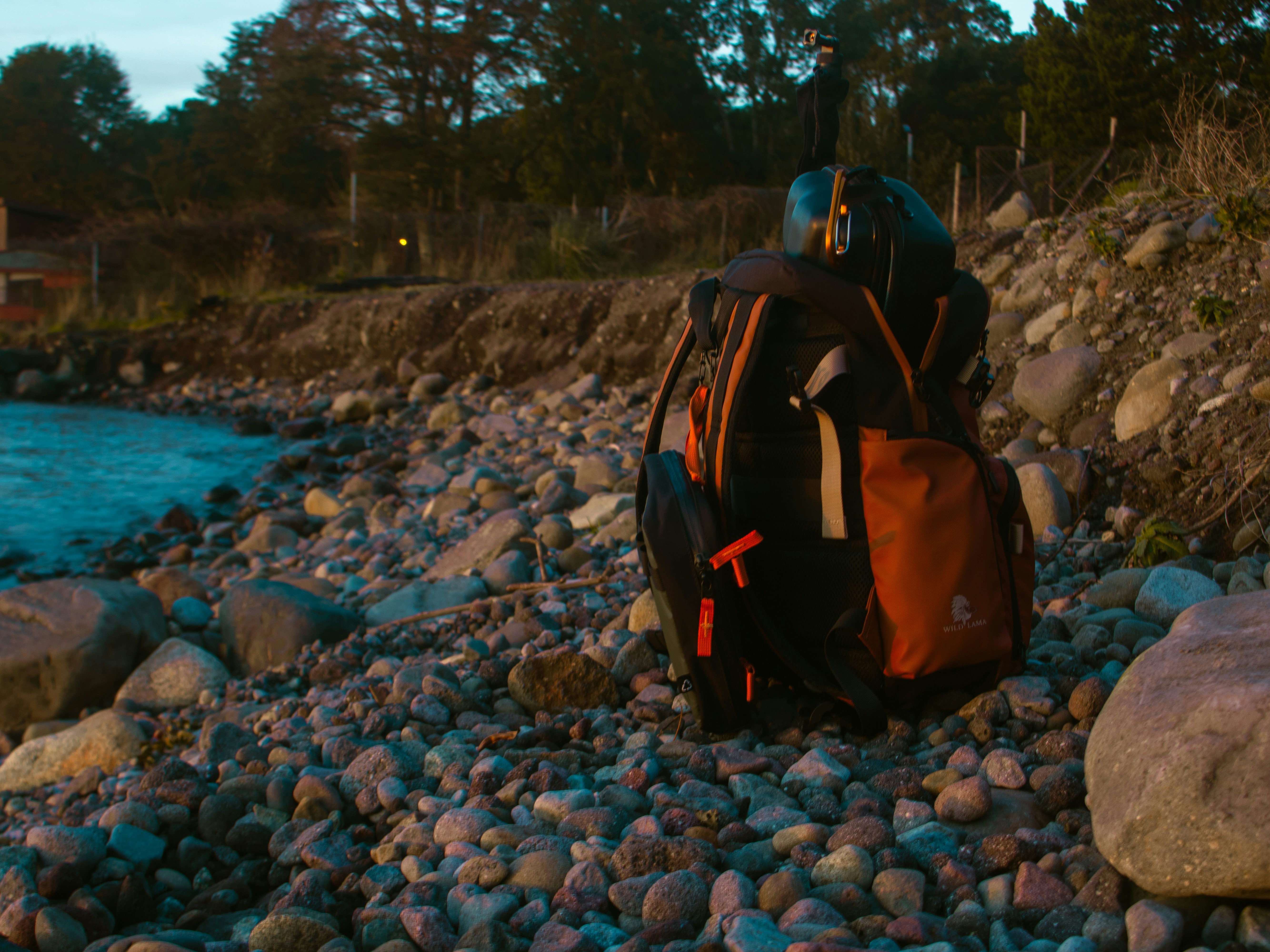 Sheltered by Pebbles: A Hiking Pack Afire with Twilight Hue