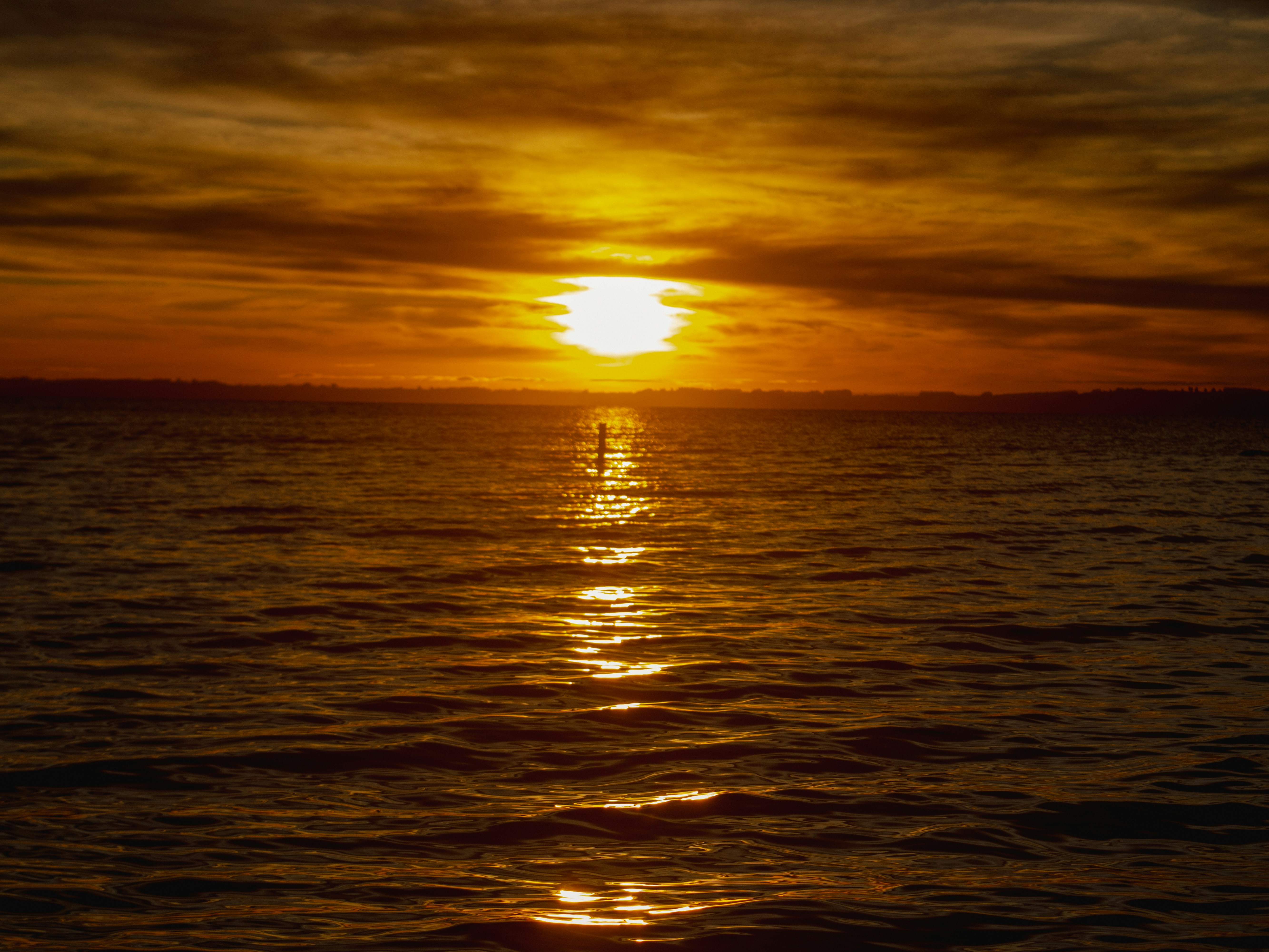 Solitary Sun Glint Across the Quiet Sea