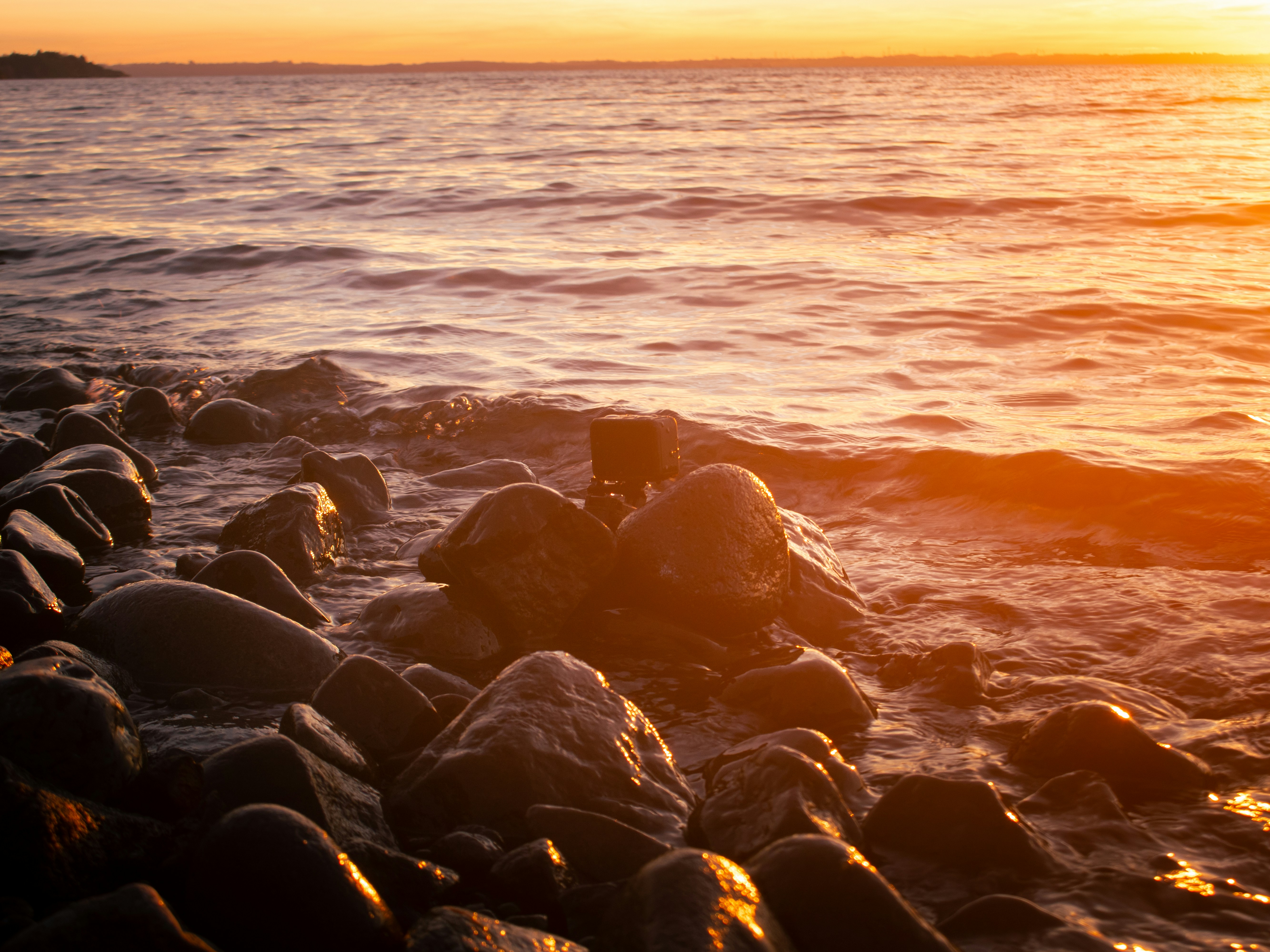 Sunlit Ledge: Juxtaposed Rocks at Dusk On the Shore