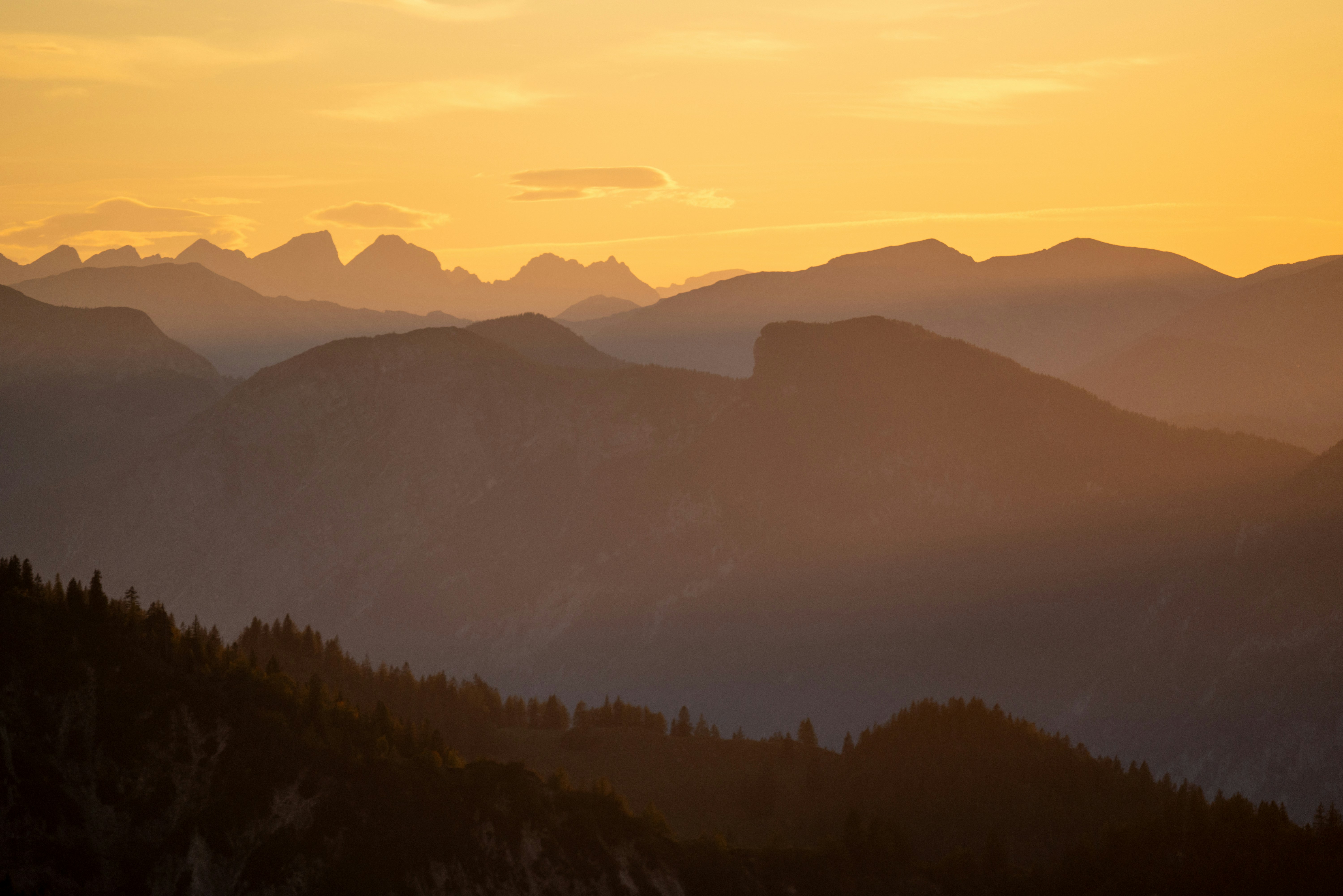Golden Ridge: Distant Peaks Beneath a Glowing Horizon