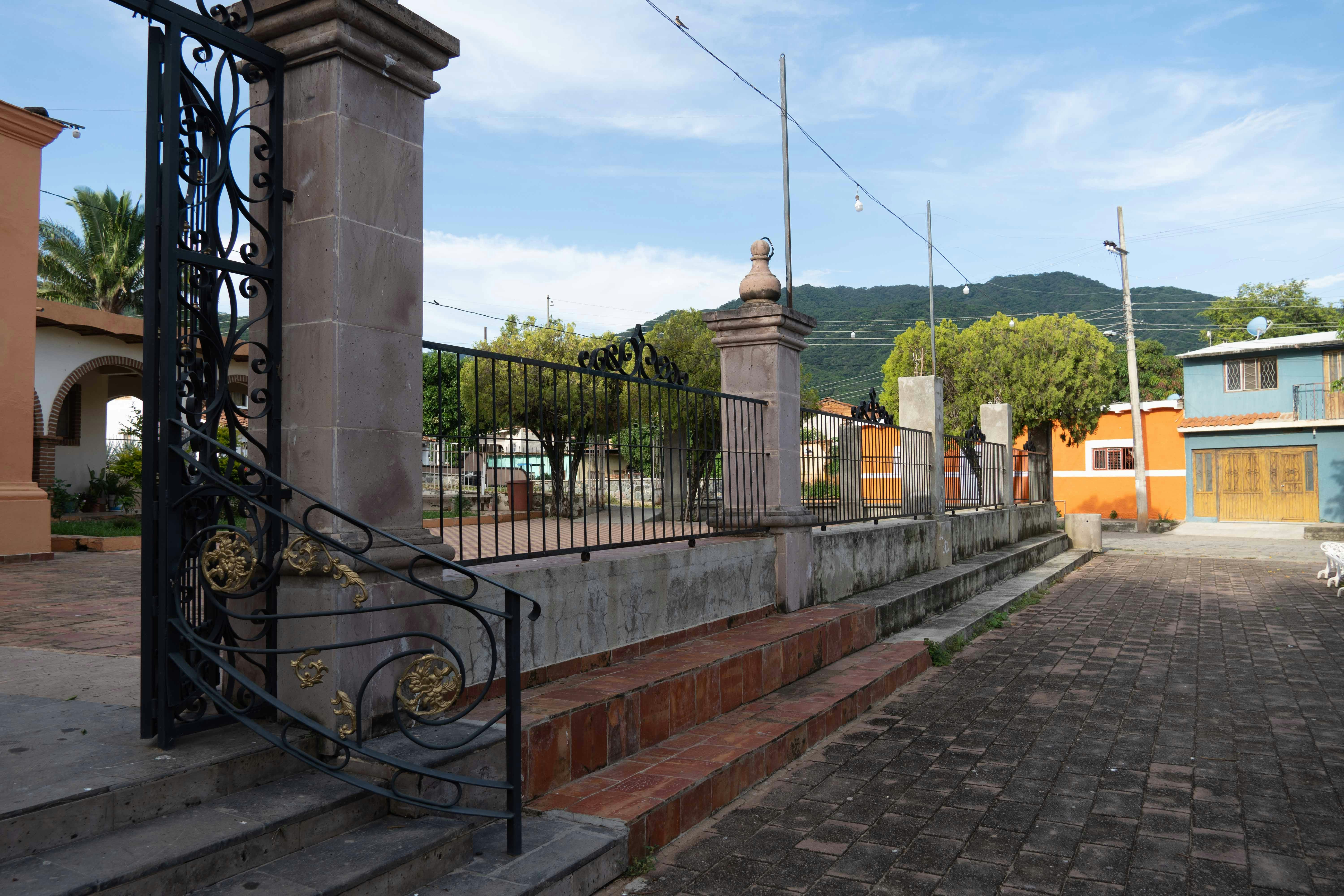 Iron Gate Facing Brick Paved Street in a Quiet Town