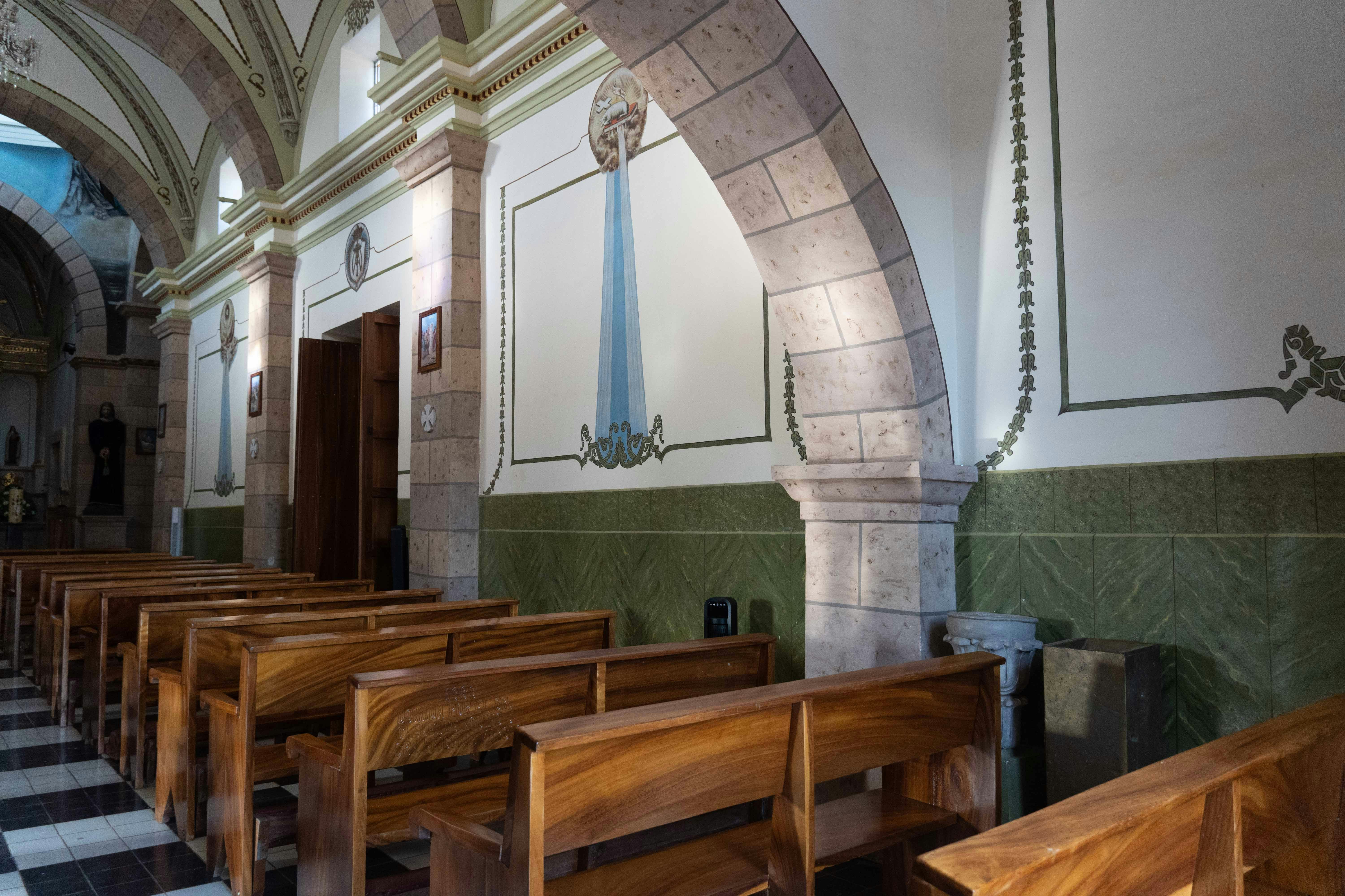 Symmetrical Nave: Wooden Benches and Arched Clerestory in Quiet Illumination