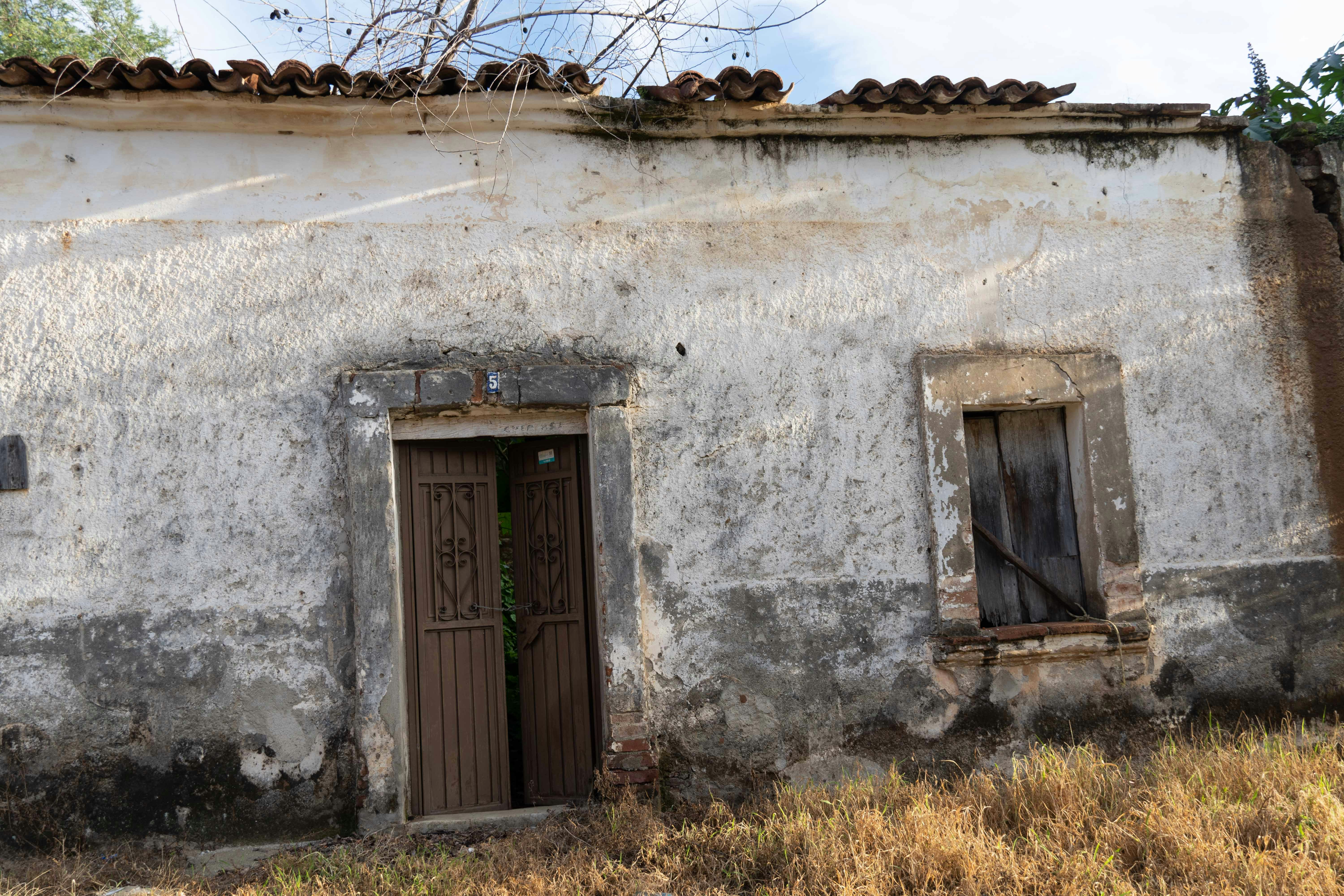 Abandoned Clay-Faced House with Weathered Doorway