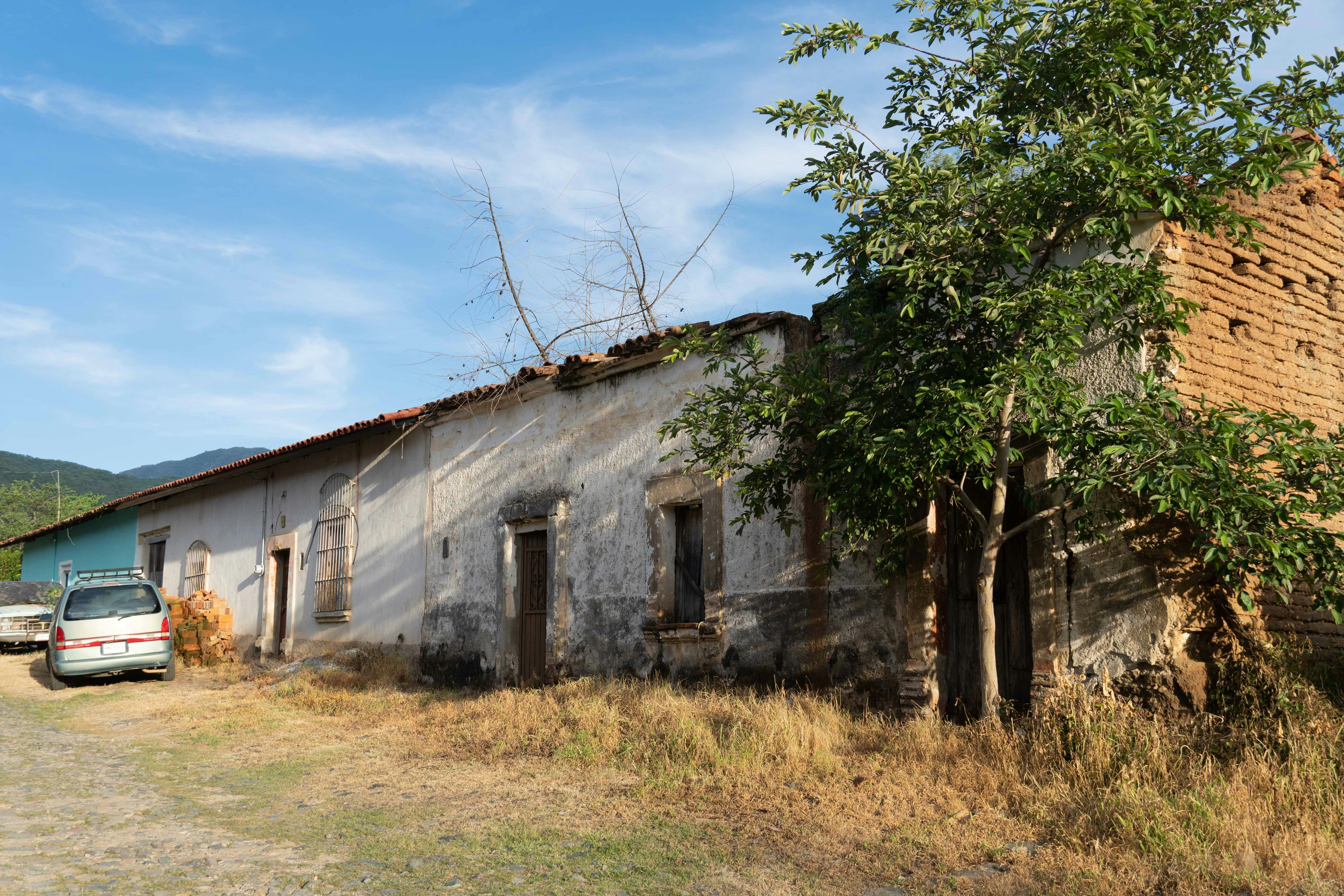 Quiet Farmhouse Row Under a Clear Noon Sky