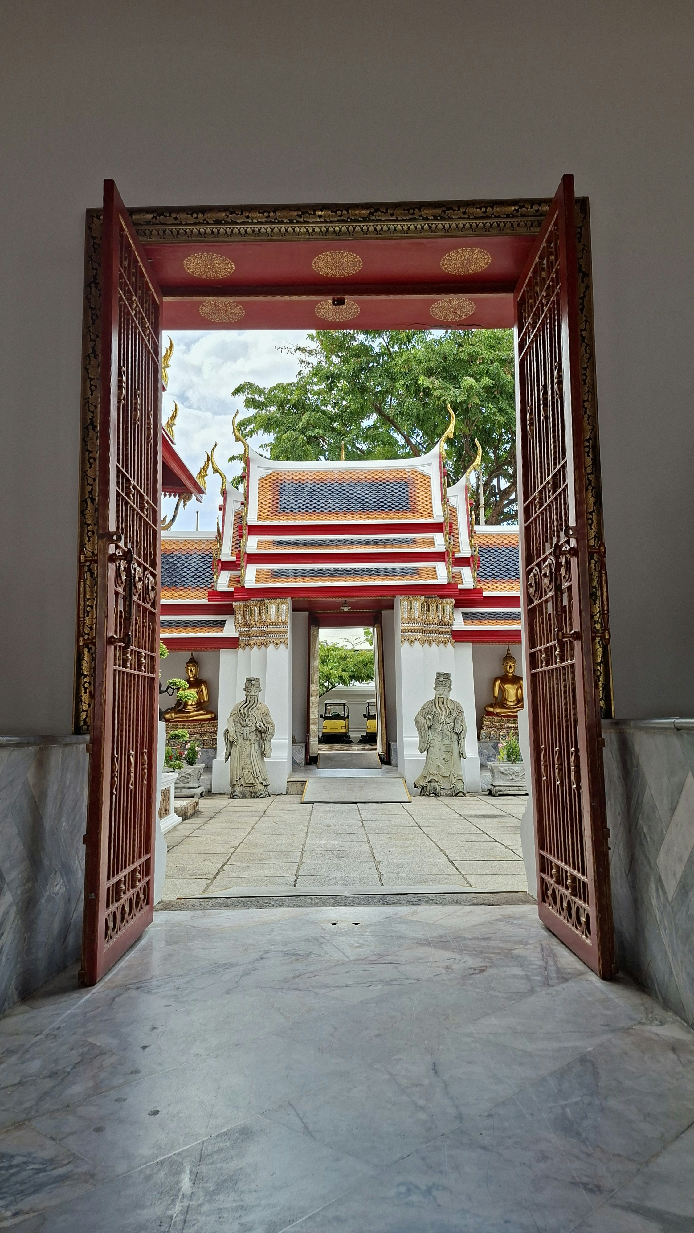 Temple Gates Open to a Courtyard of Statues and Roofline