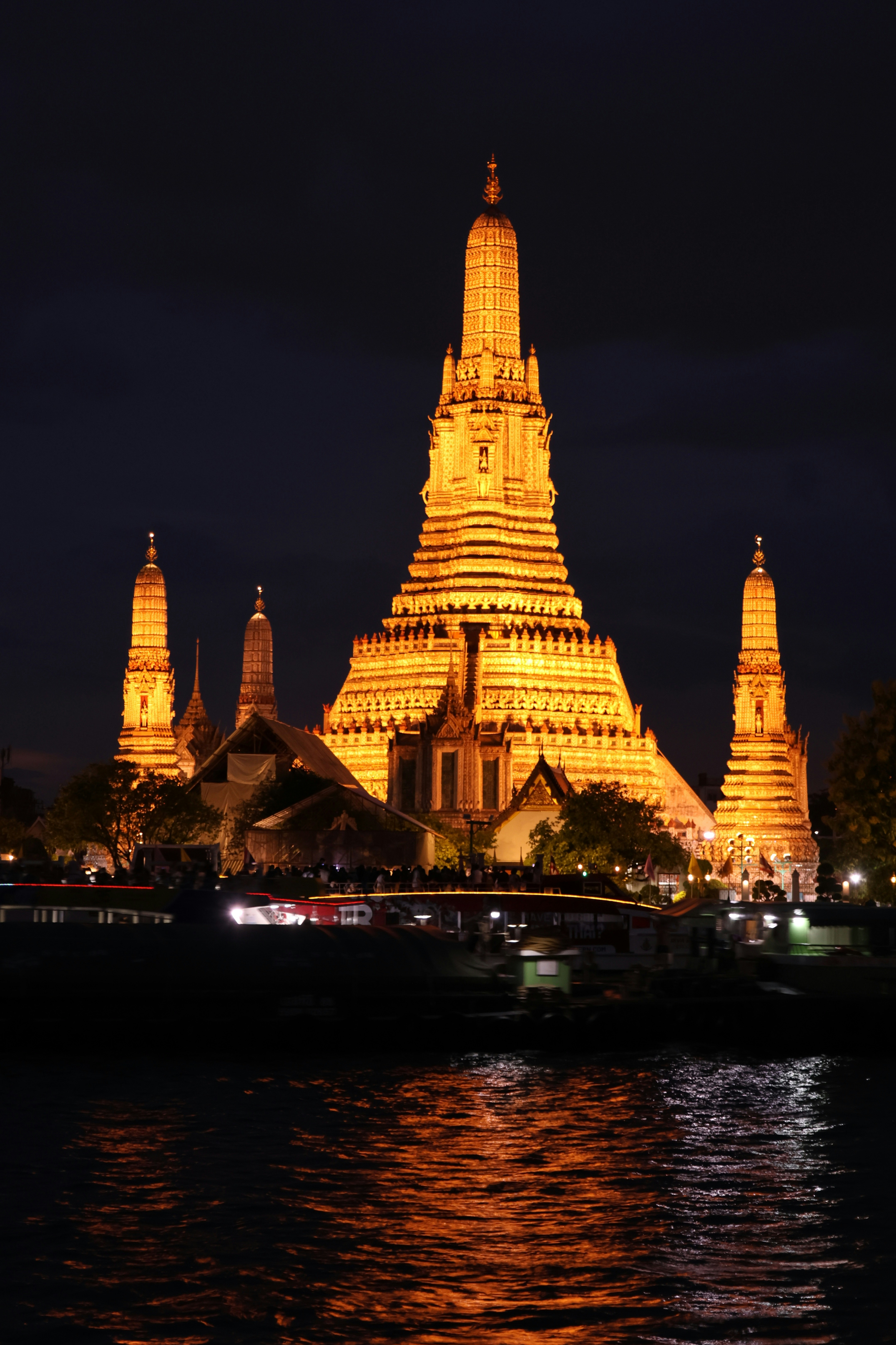 Golden Spires at Night: A Temple Cathedral Emerges from the River
