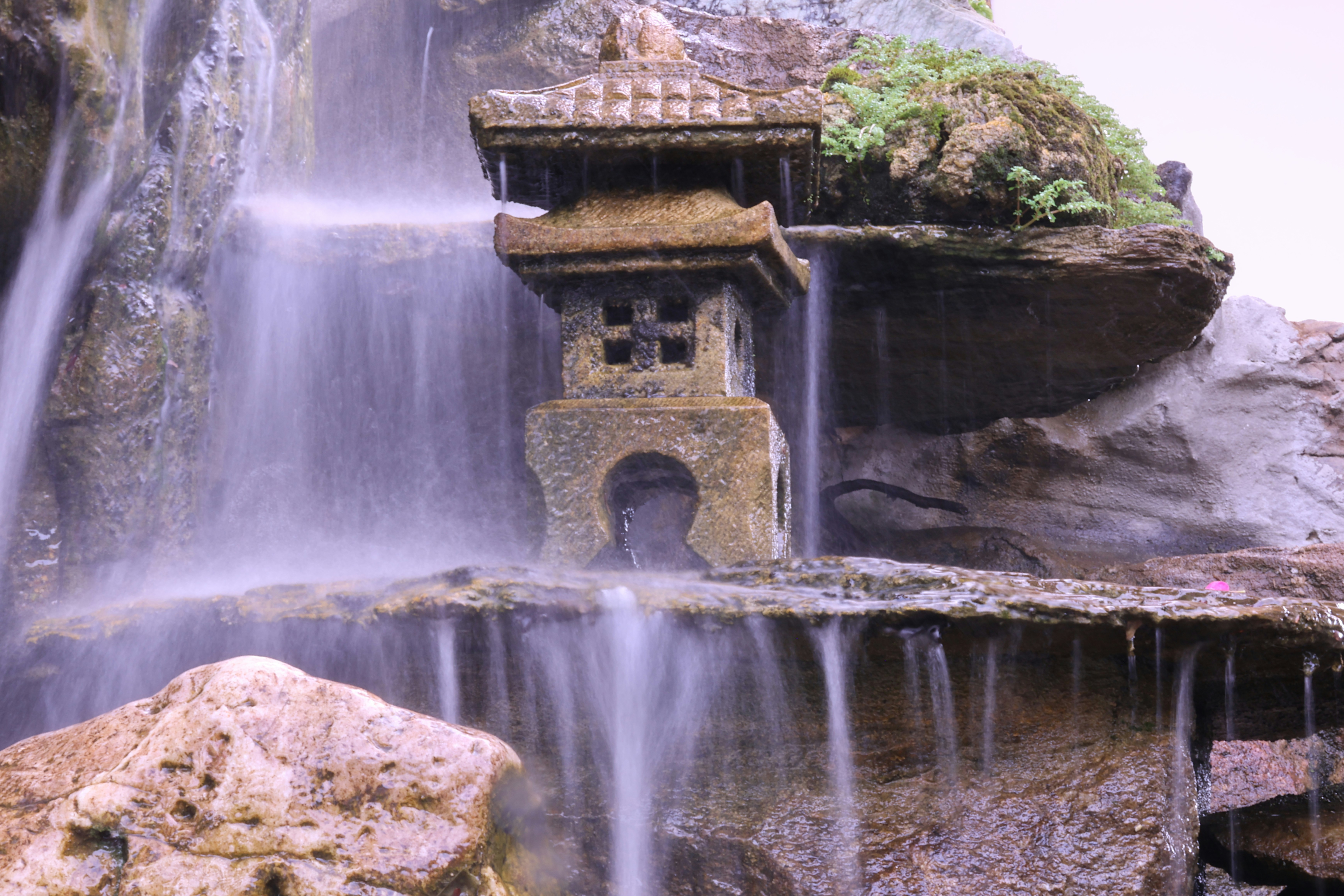 Miniature Pagoda by the Veil: A Gentle Cascade over Stone Lanterns
