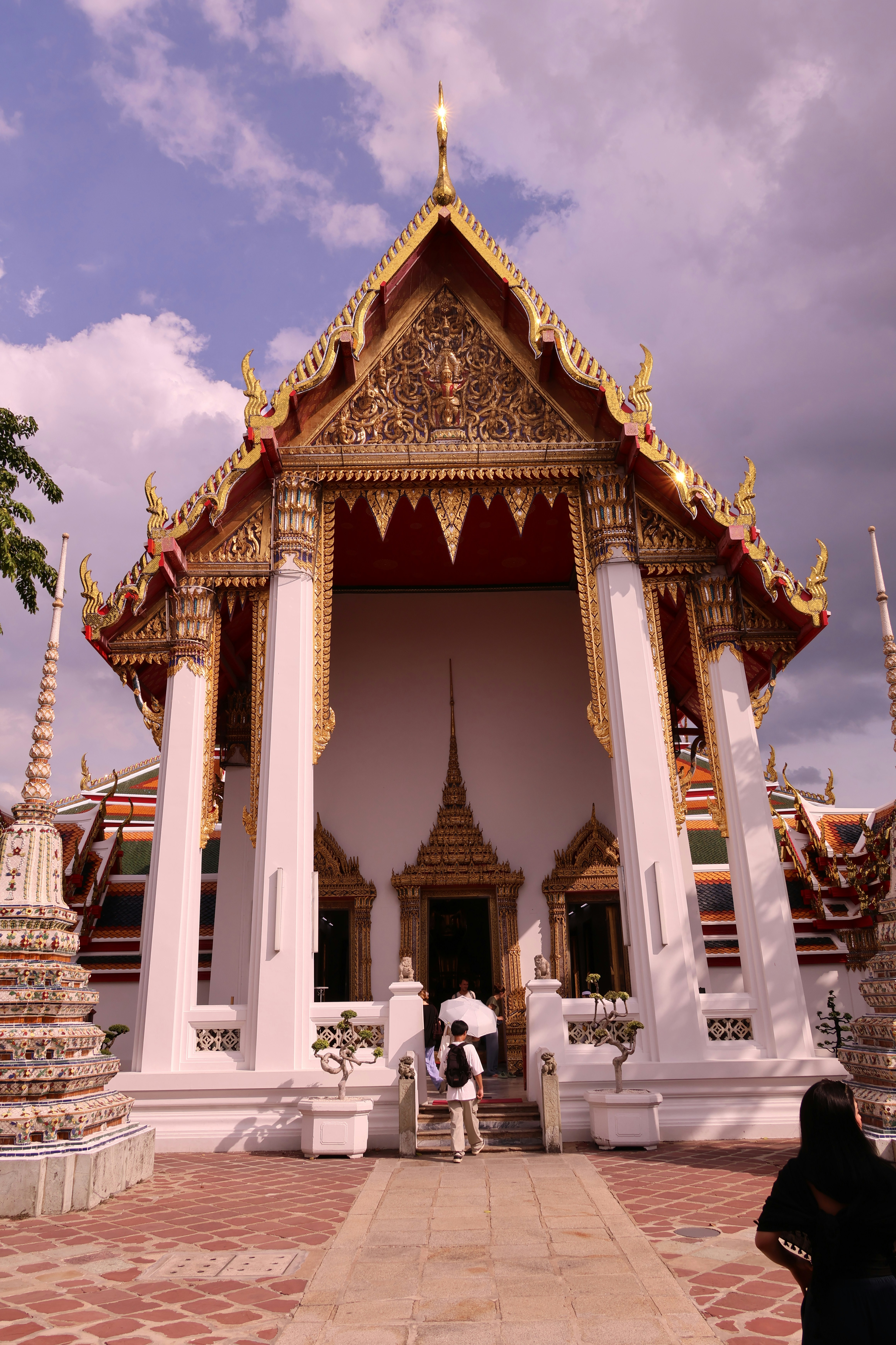  ornate temple facade framed by towering pillars at golden hour