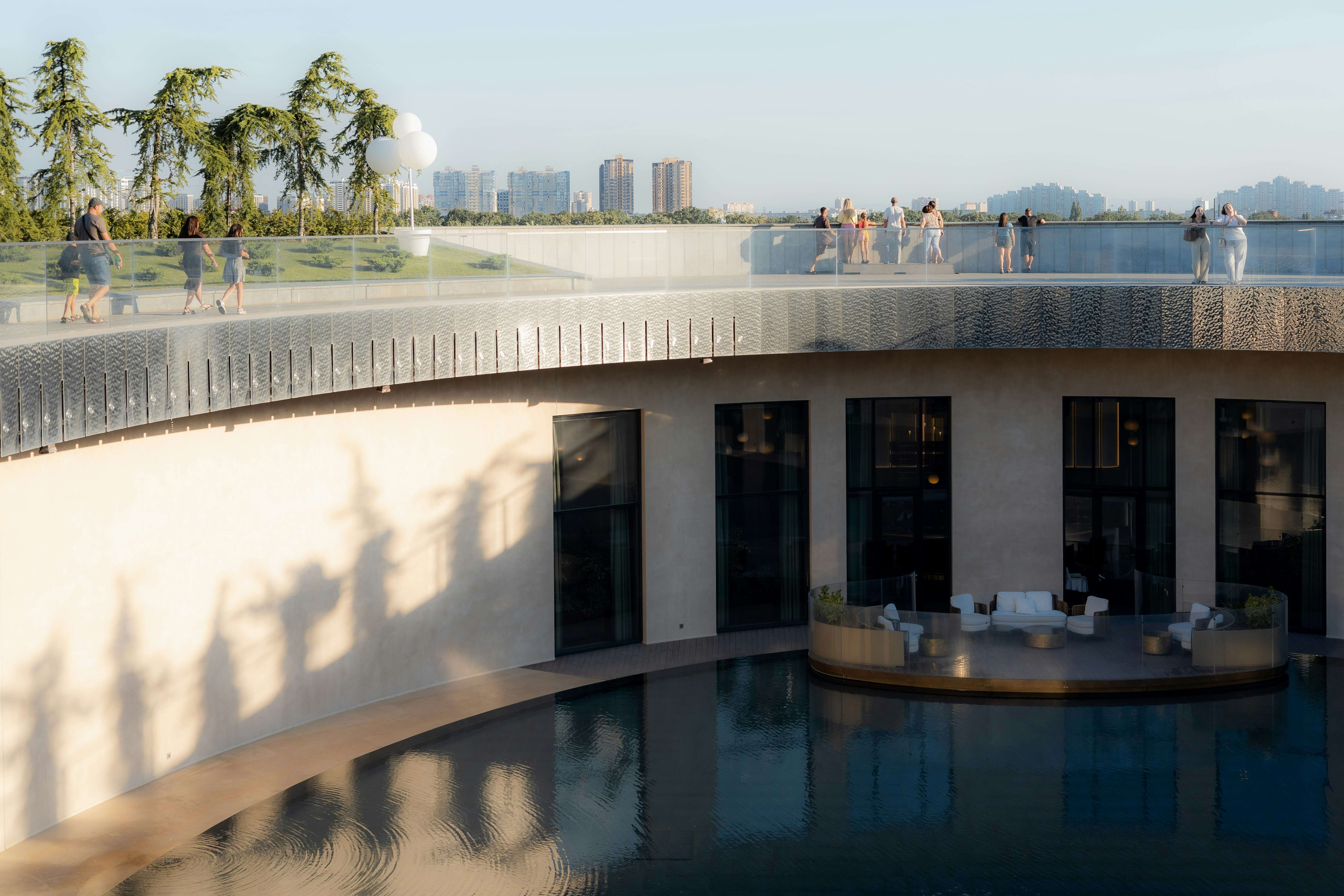 Rooftop Pier over tranquil pool with shadowed facade and cityscape