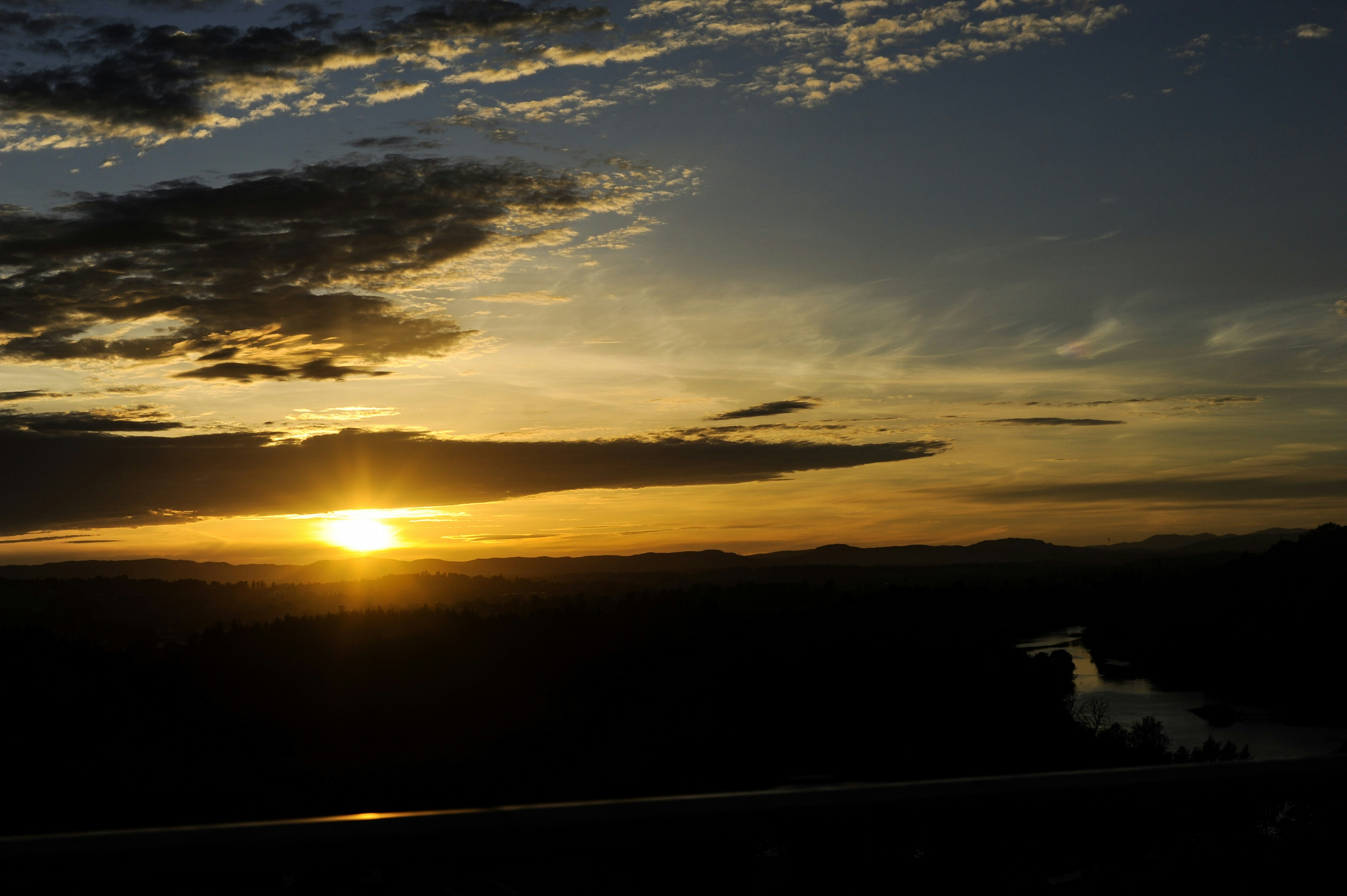Sunlit Horizon: A Quiet River at Dusk