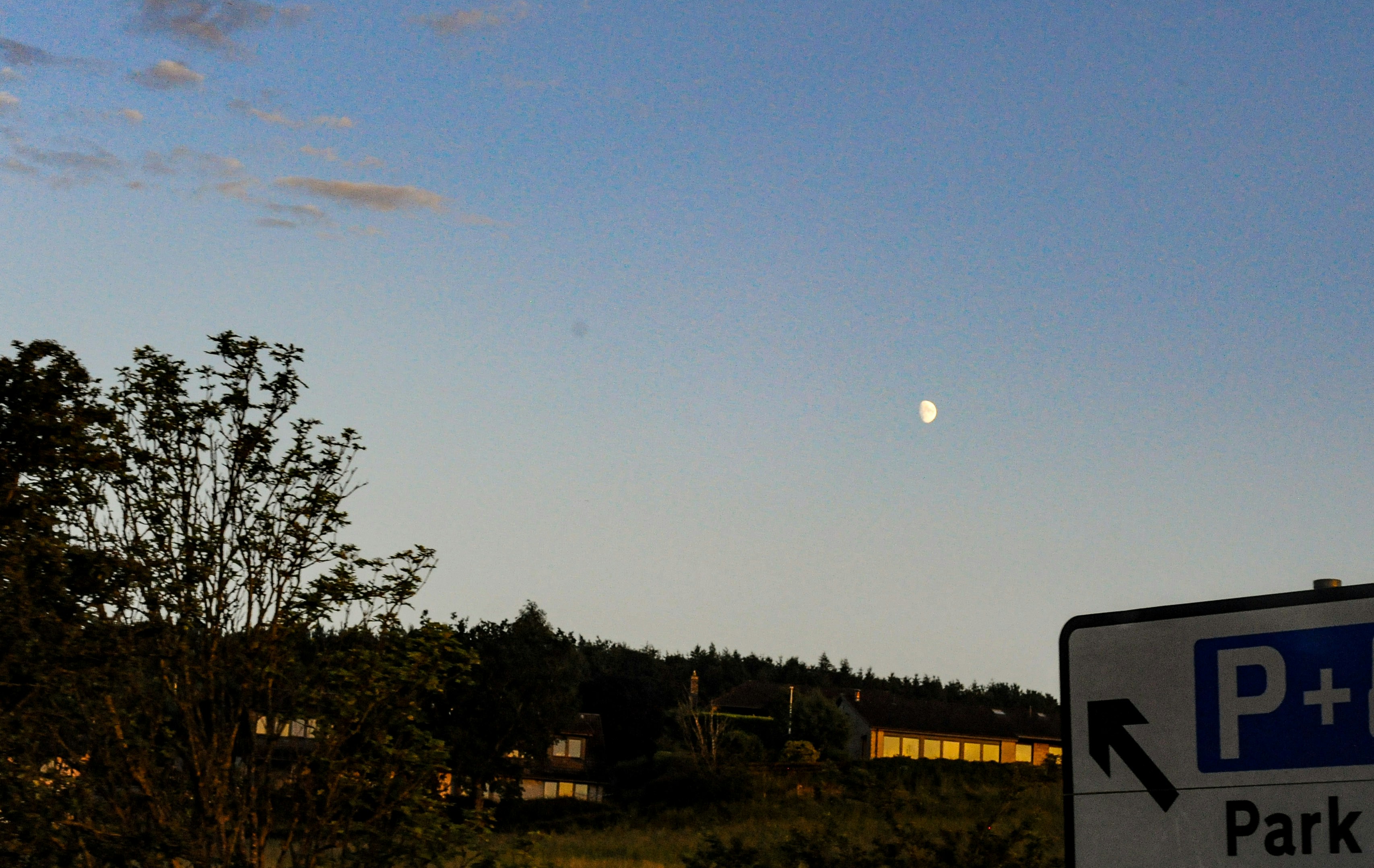 Moon Above the Parked Sign at Dusk
