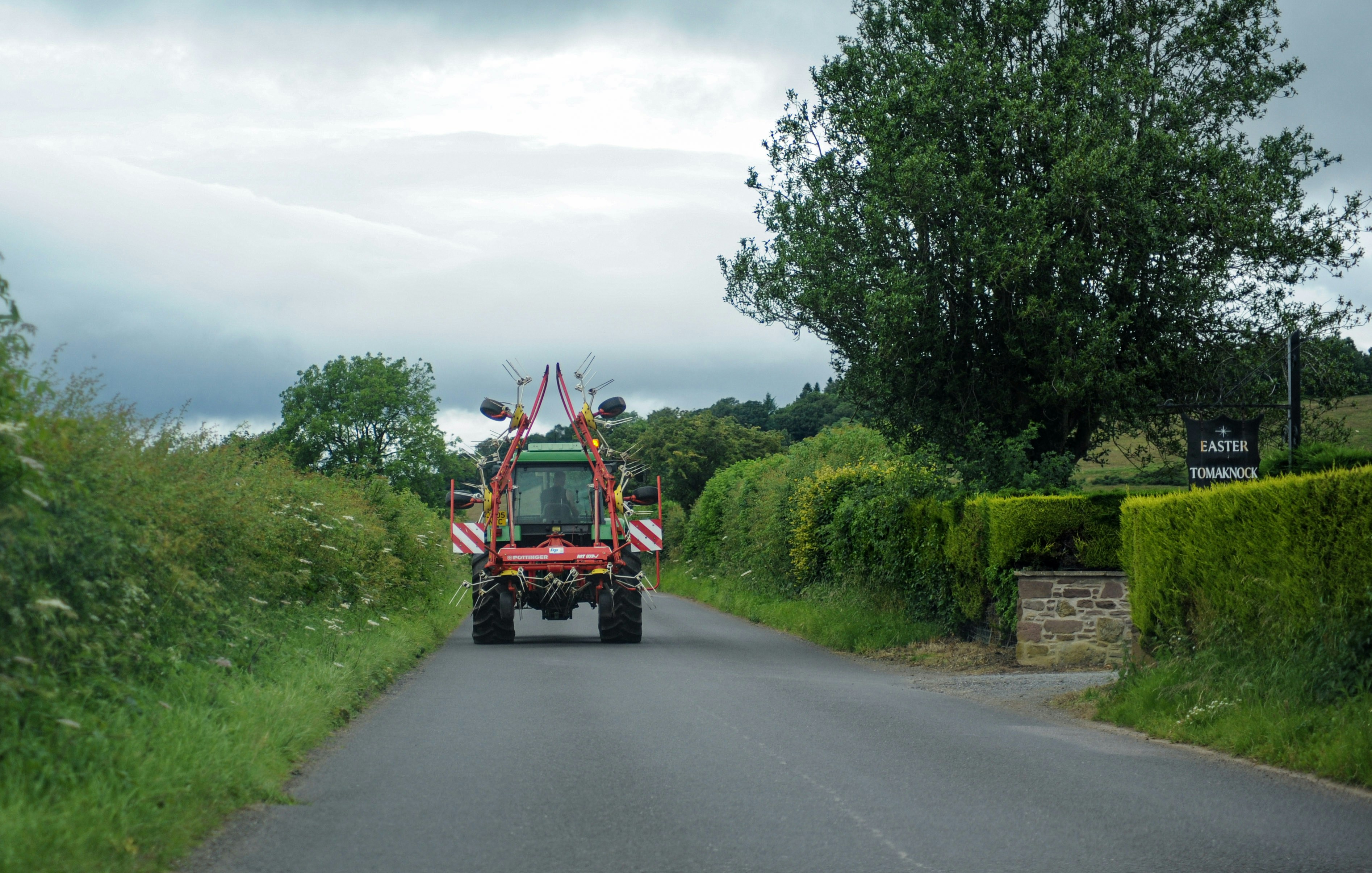 Red Tractor Parade on a Quiet Lane