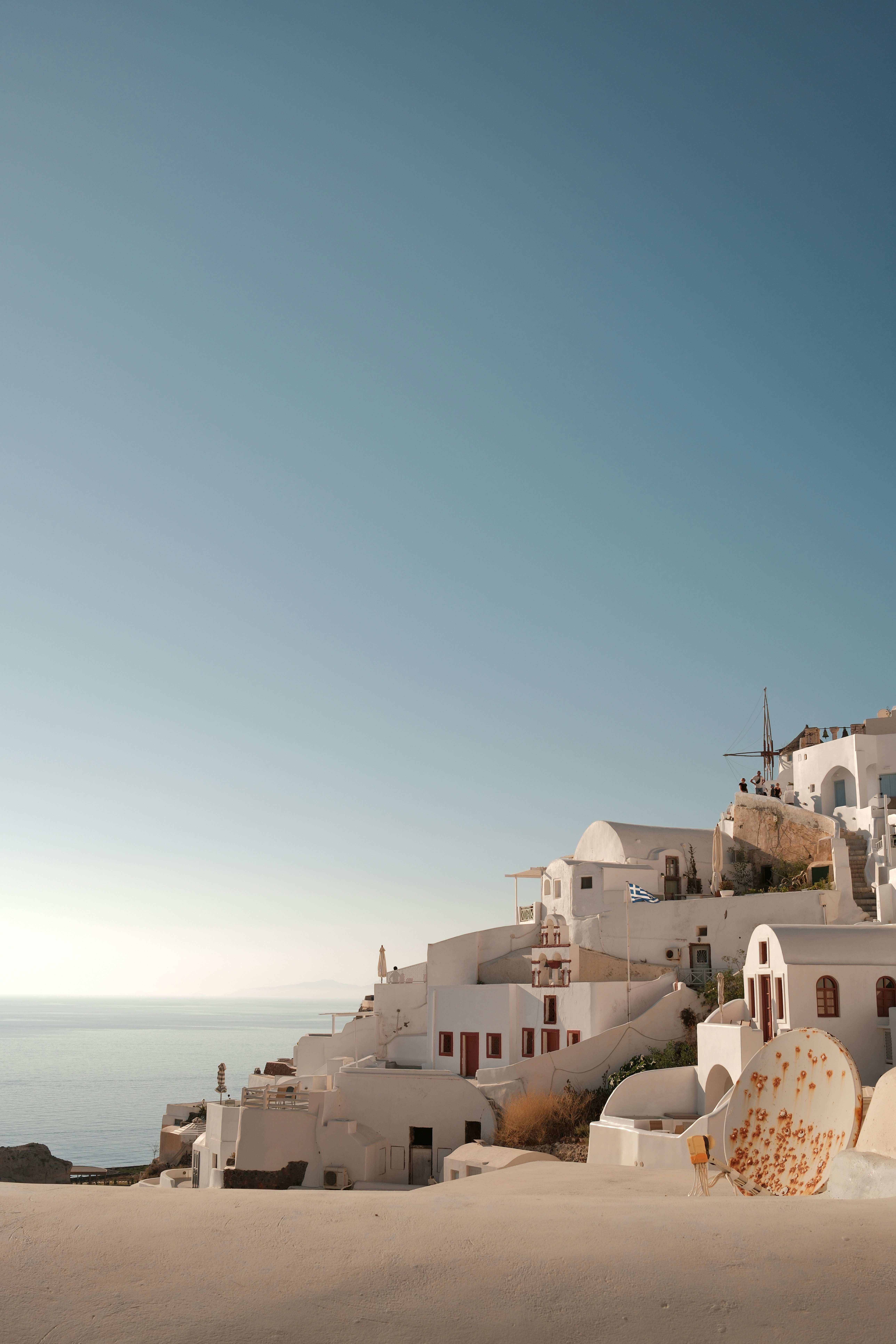 Aegean White: Cliffside Village Stairs under Clear Skies