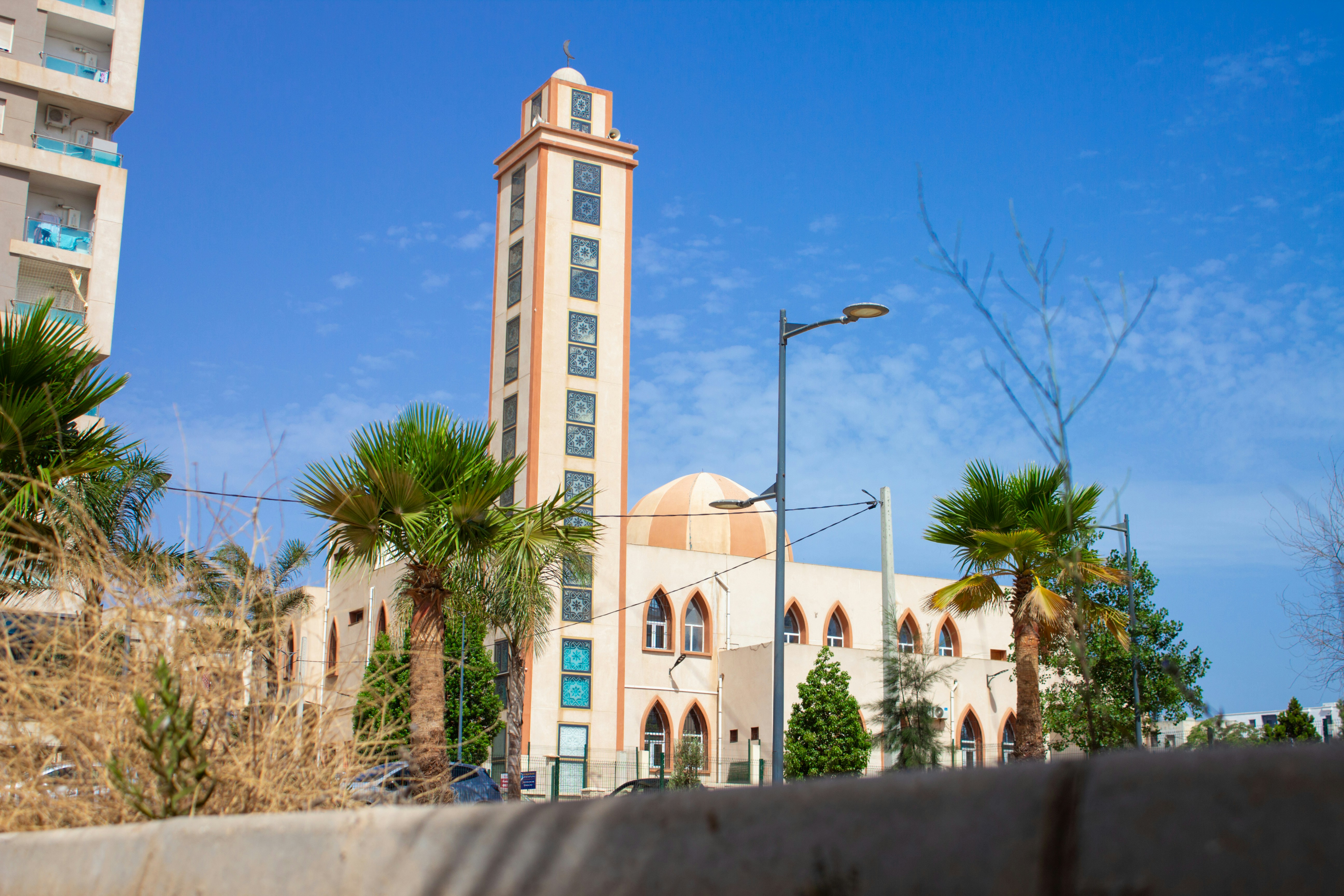 Clock Tower and Mission-Style Complex Under a Bright Coastal Sky