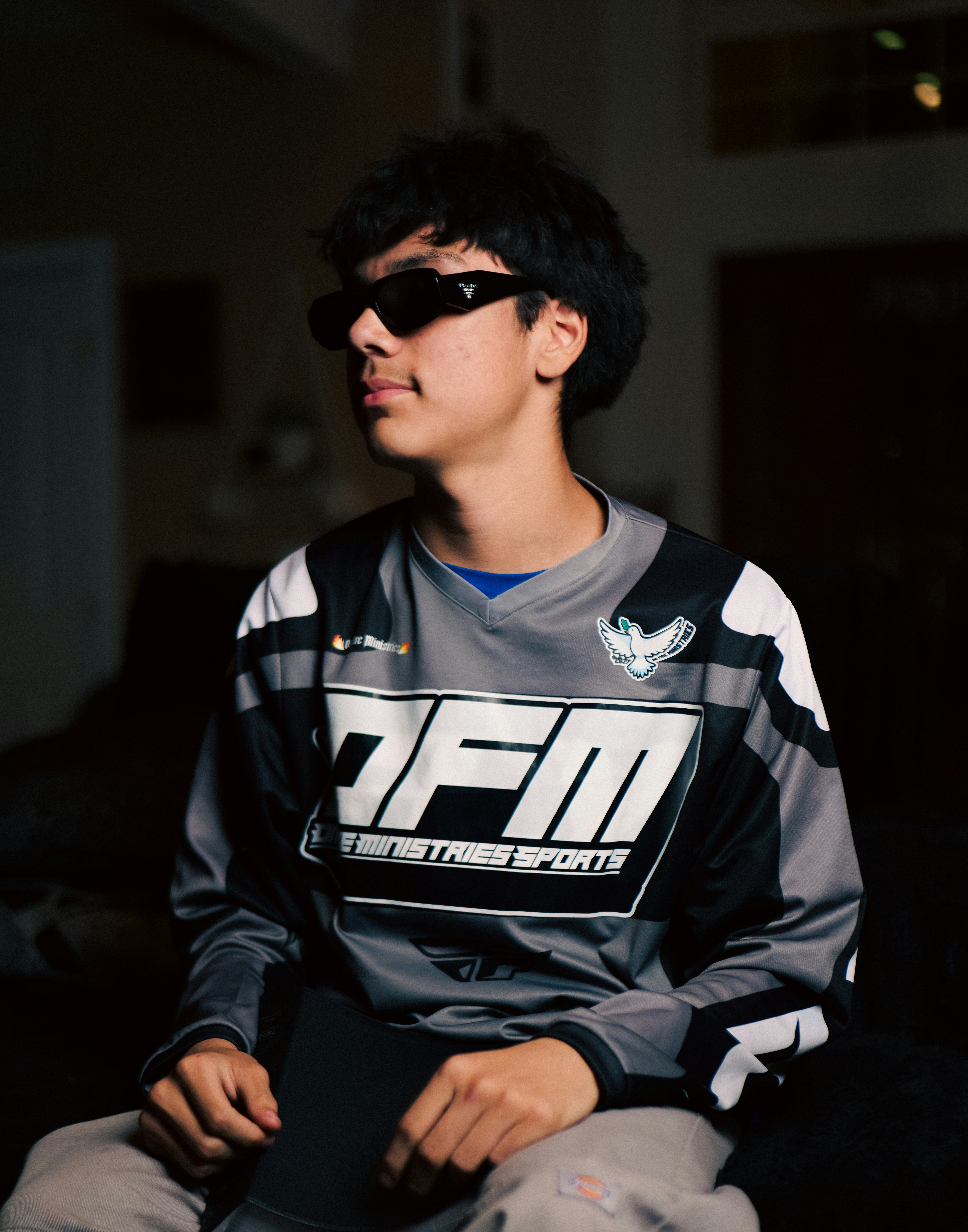 Shadowed Focus: A Teen in Sunglasses and Graphical Gear