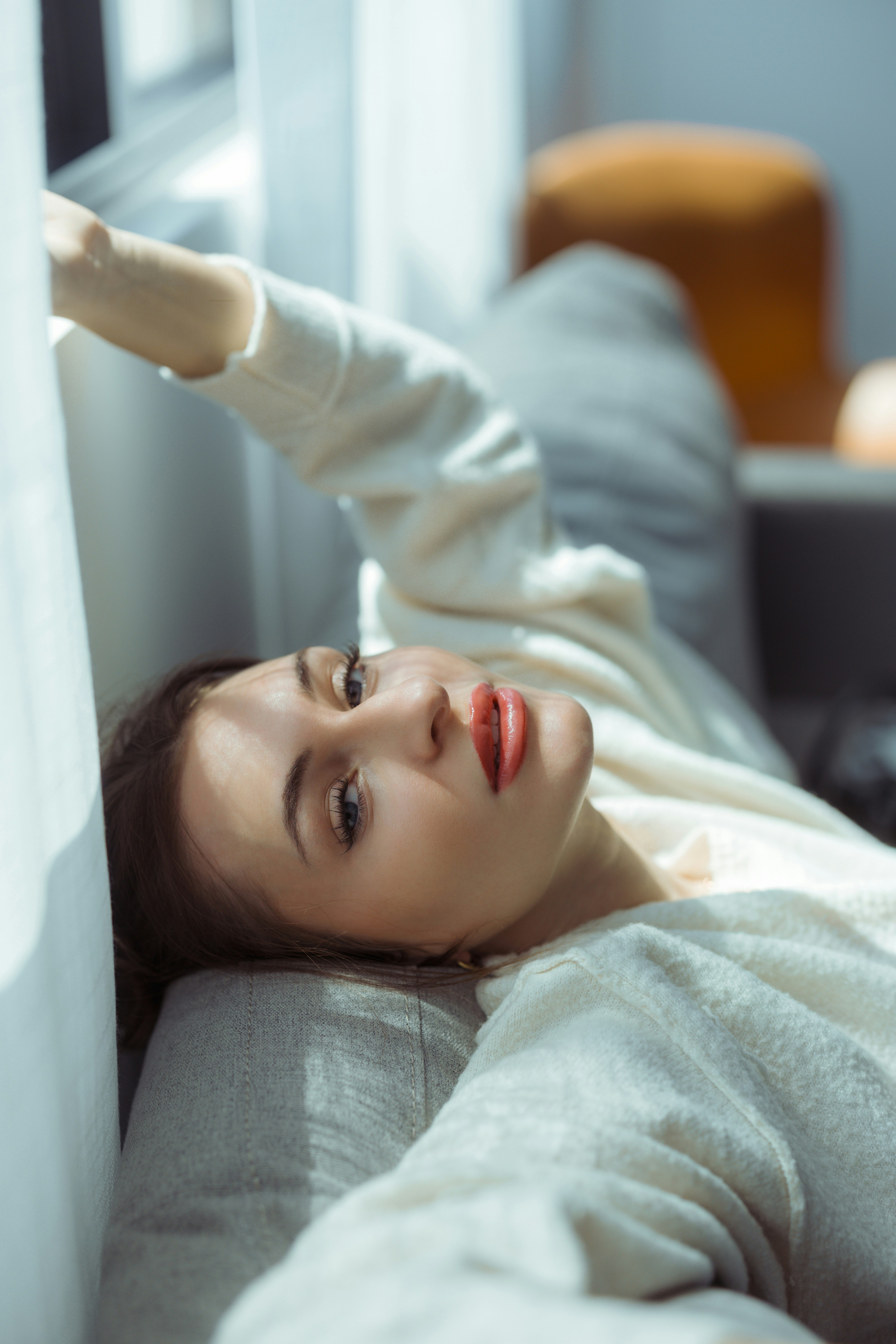 Soft Focus Intimacy: A Woman Reclines by Window Light