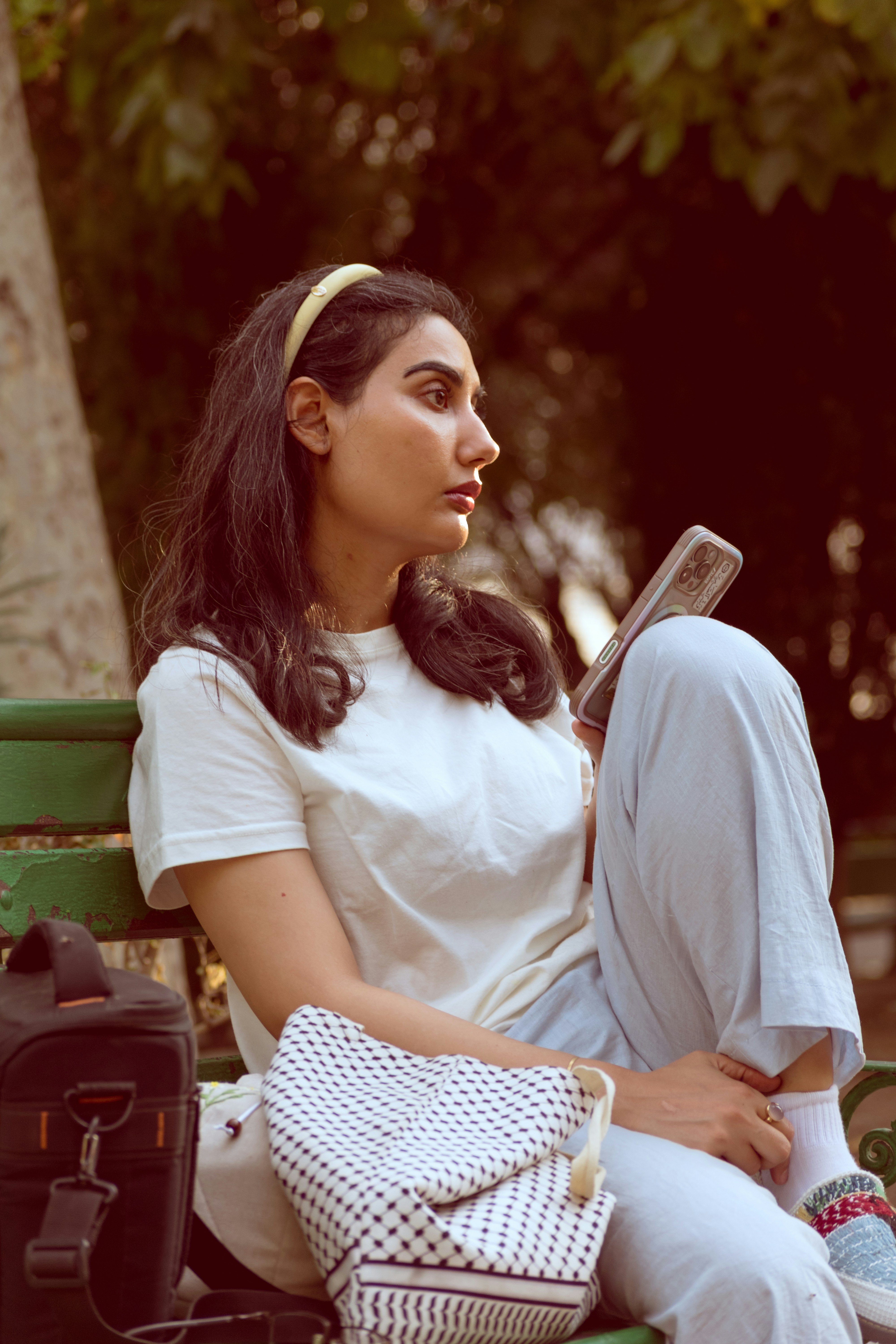 Portrait on a Park Bench: Quiet Contemplation with a Phone