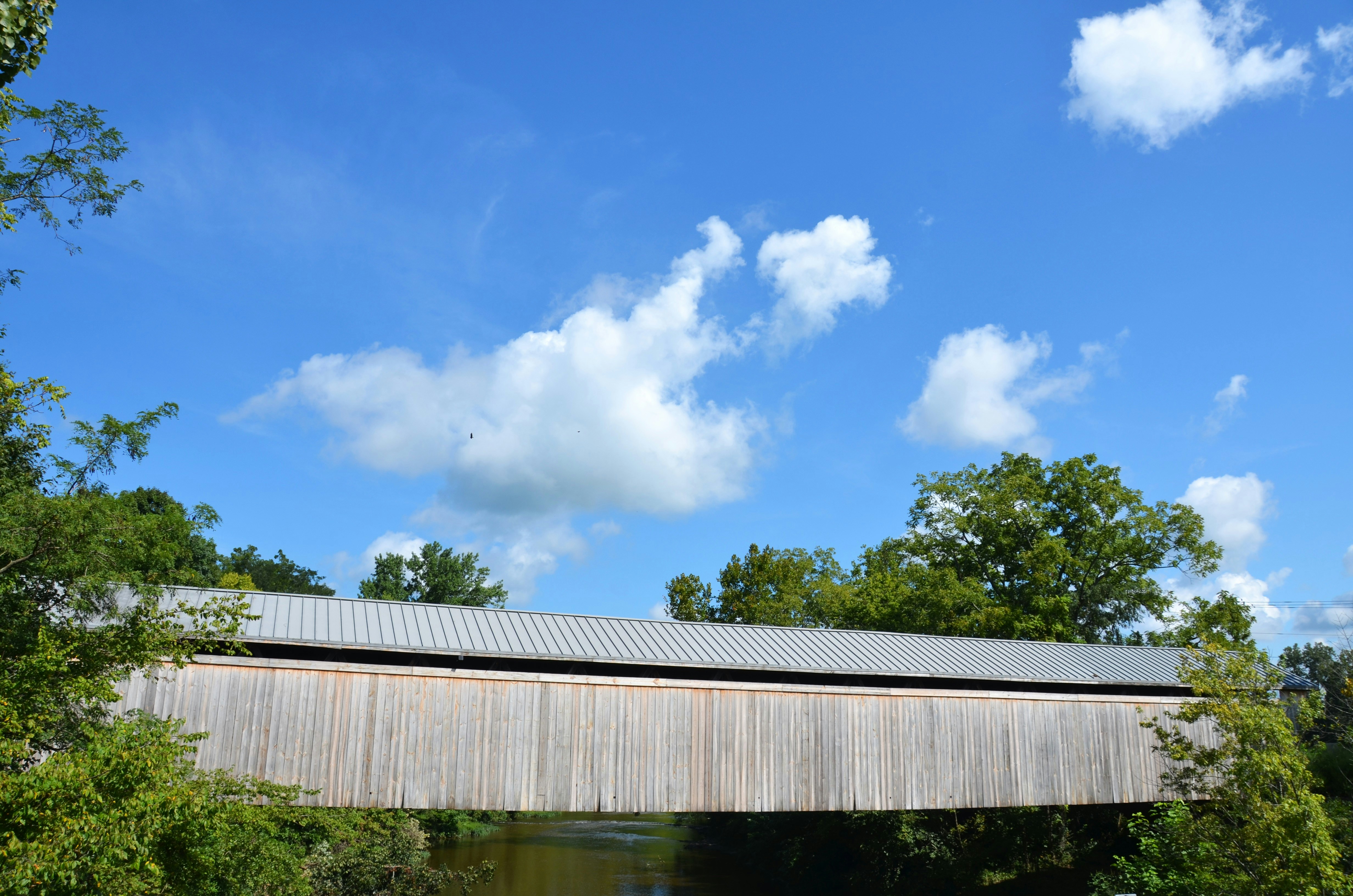 Rustic Covered Bridge Under a Clear Blue Sky