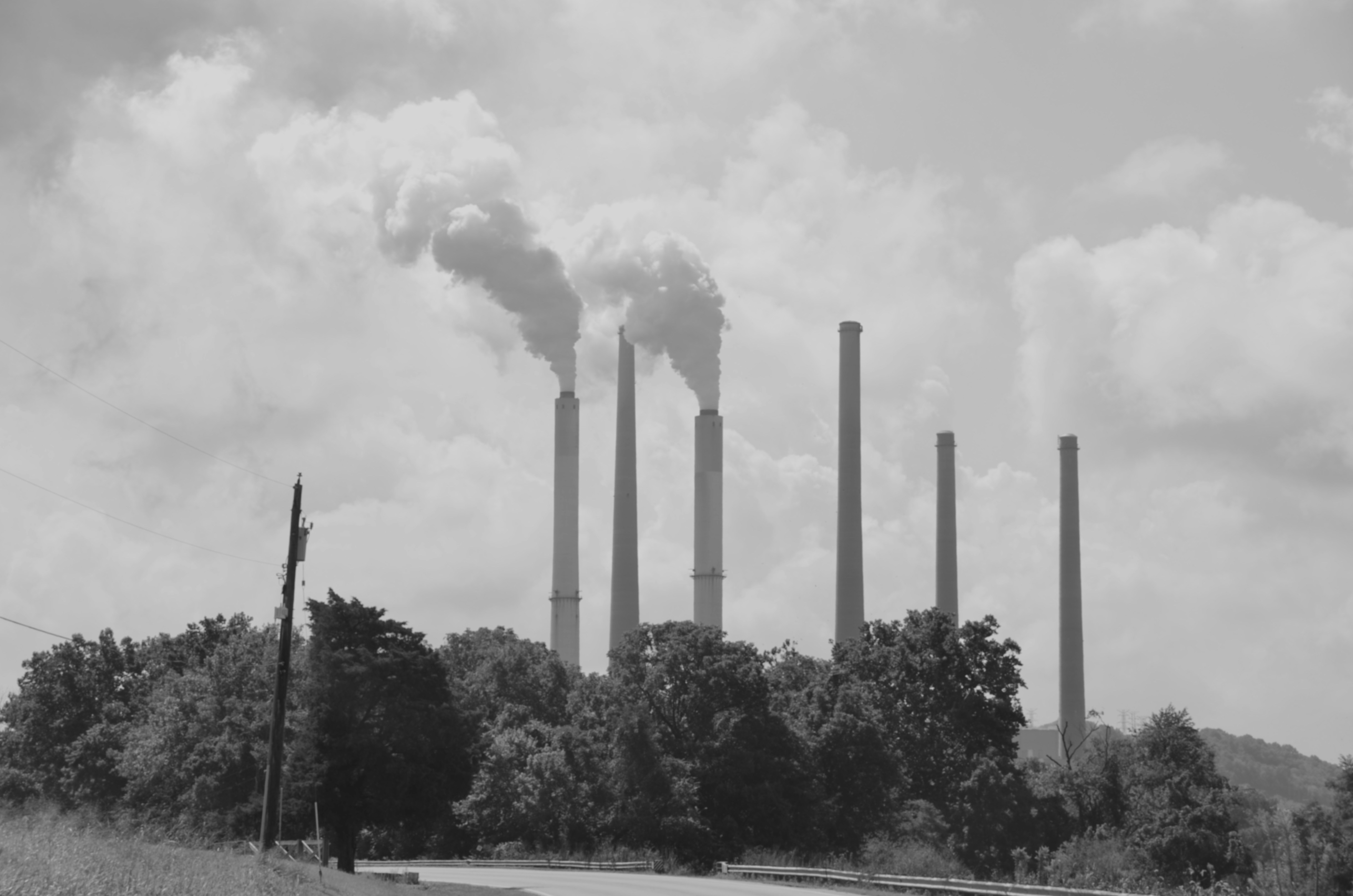 Factory Smoke Across a Ridge: Quiet Monochrome Valley