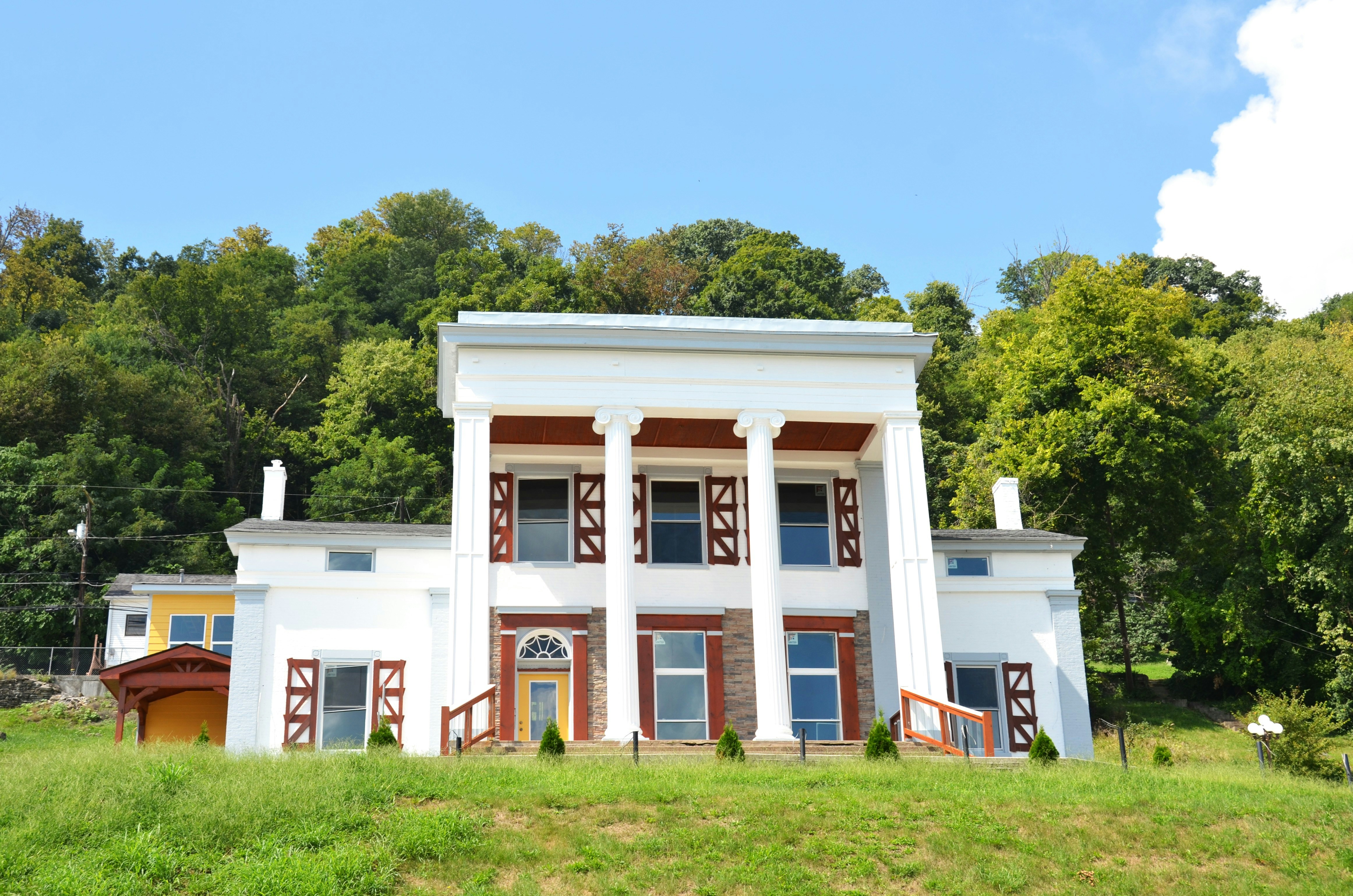 Classical Villa Emerges from Green Hill