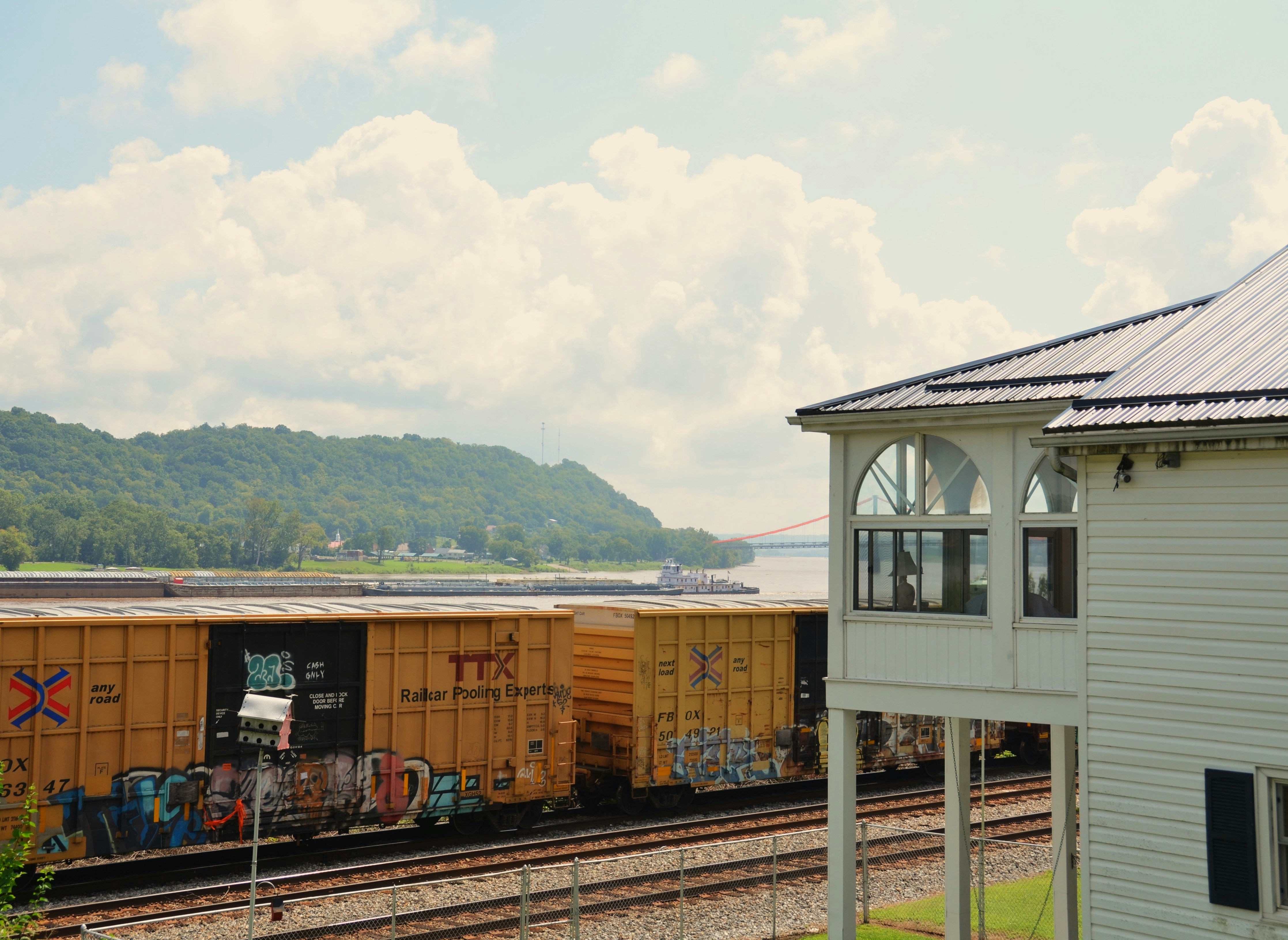Industrial Trackside Vista: Train Cars and a Cornered Building