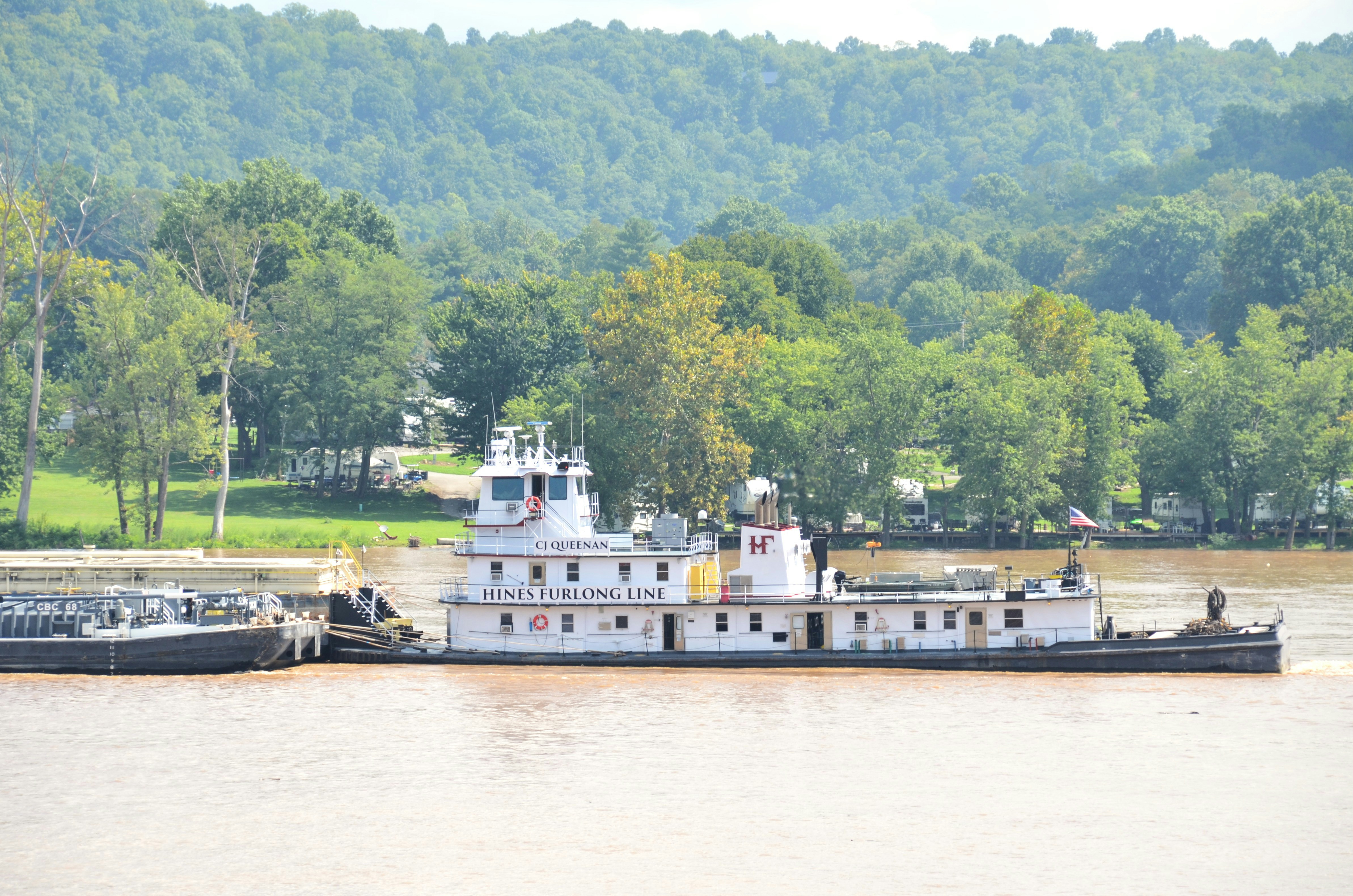 Towboat on the River: Calm Waters, Quiet Docks, and Distant Greenery