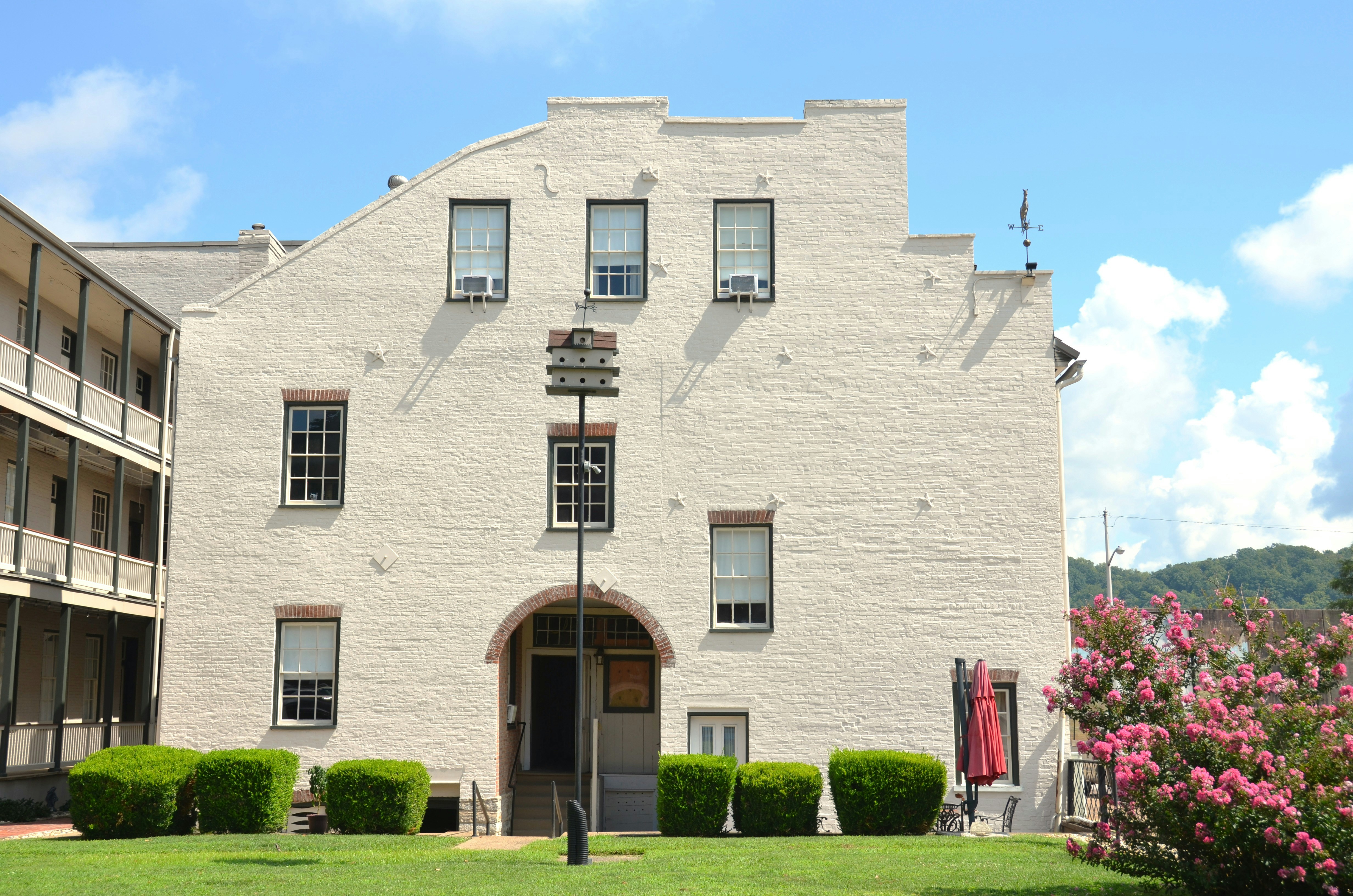 Beige Campus Facade with Painted Archway and Landscaping